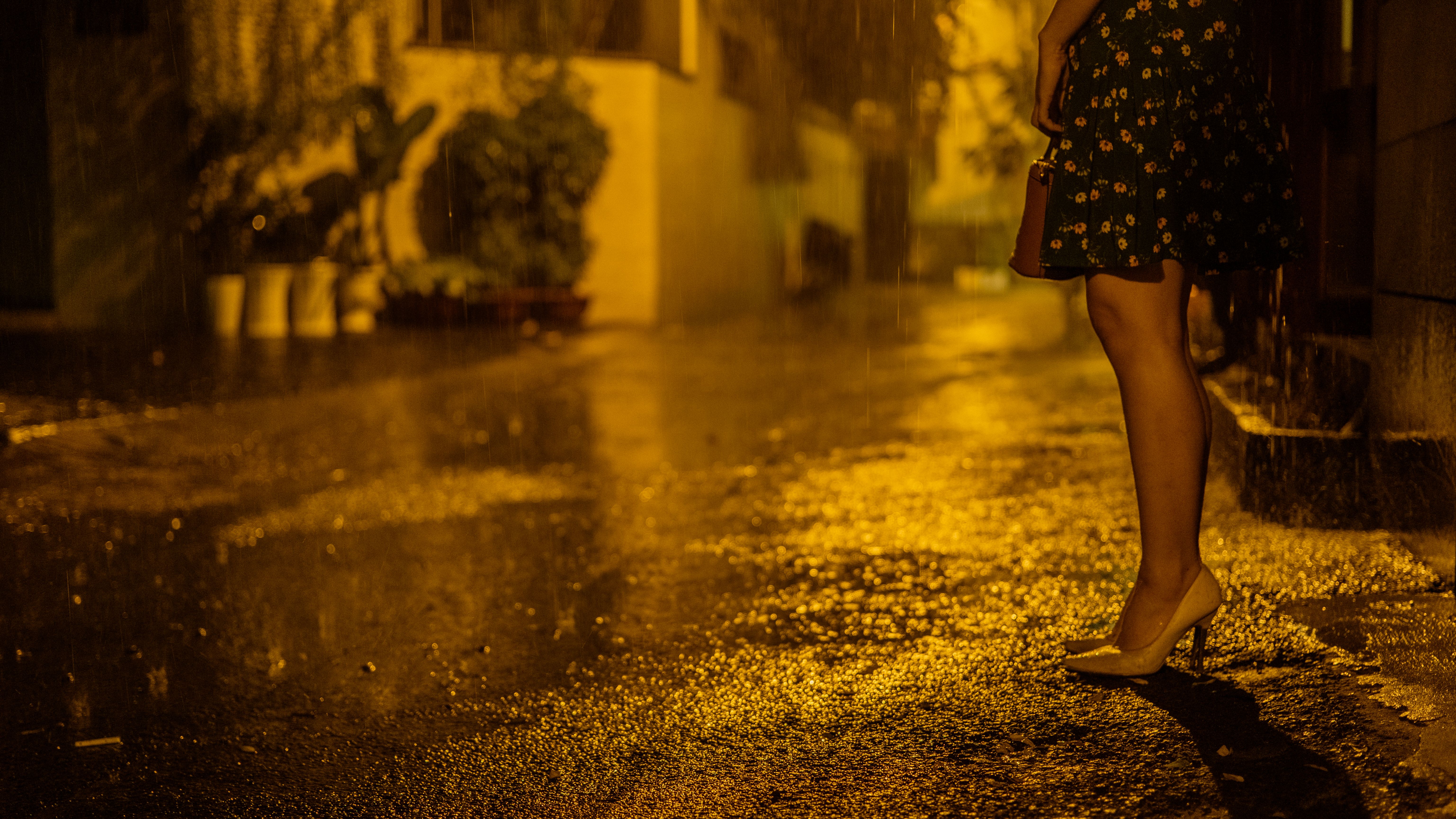 Woman in a Dress and Heels Standing on a Street in City during Rain ...