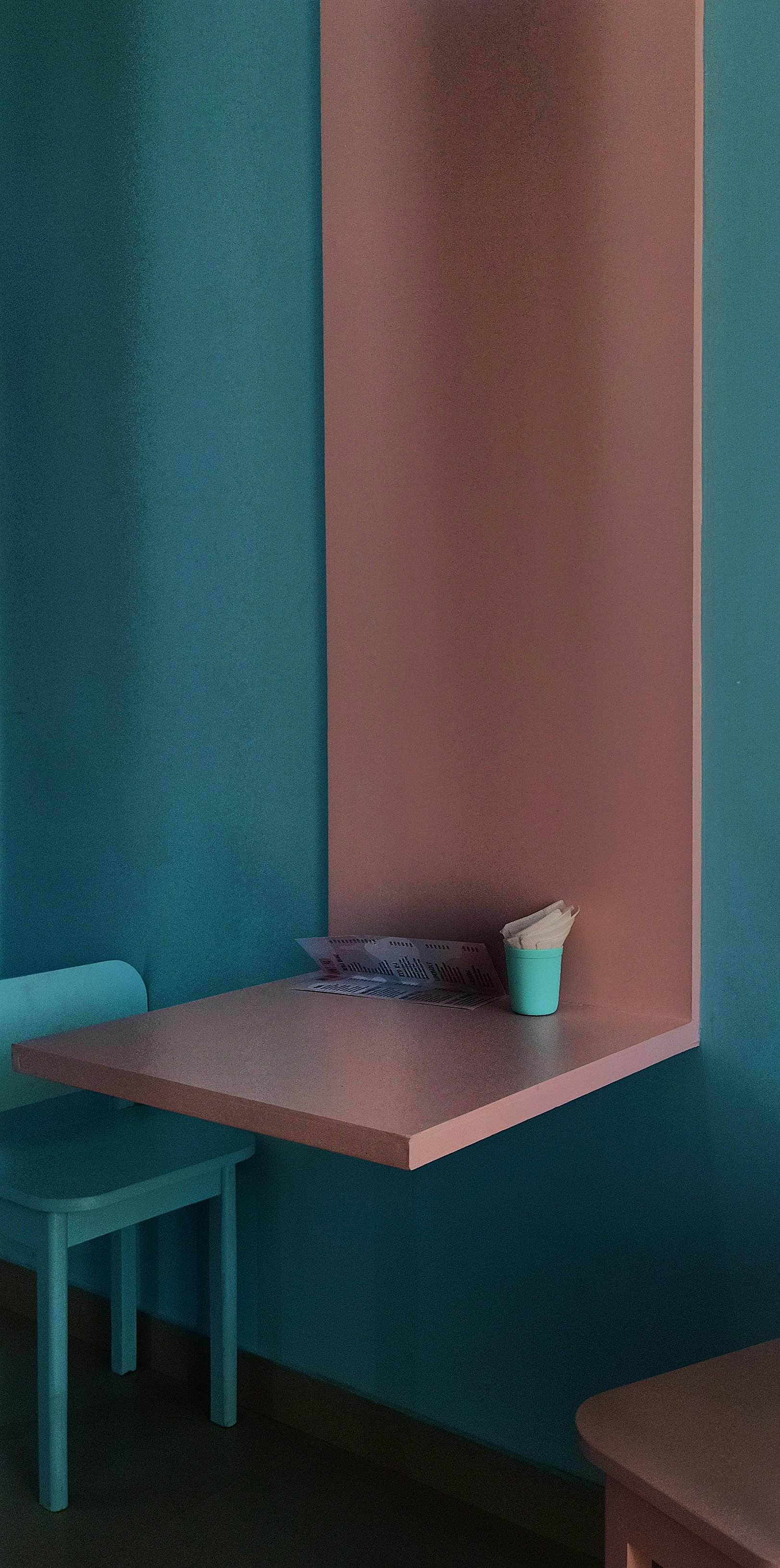 Turquoise Bar Interior with a Table and a Chair · Free Stock Photo