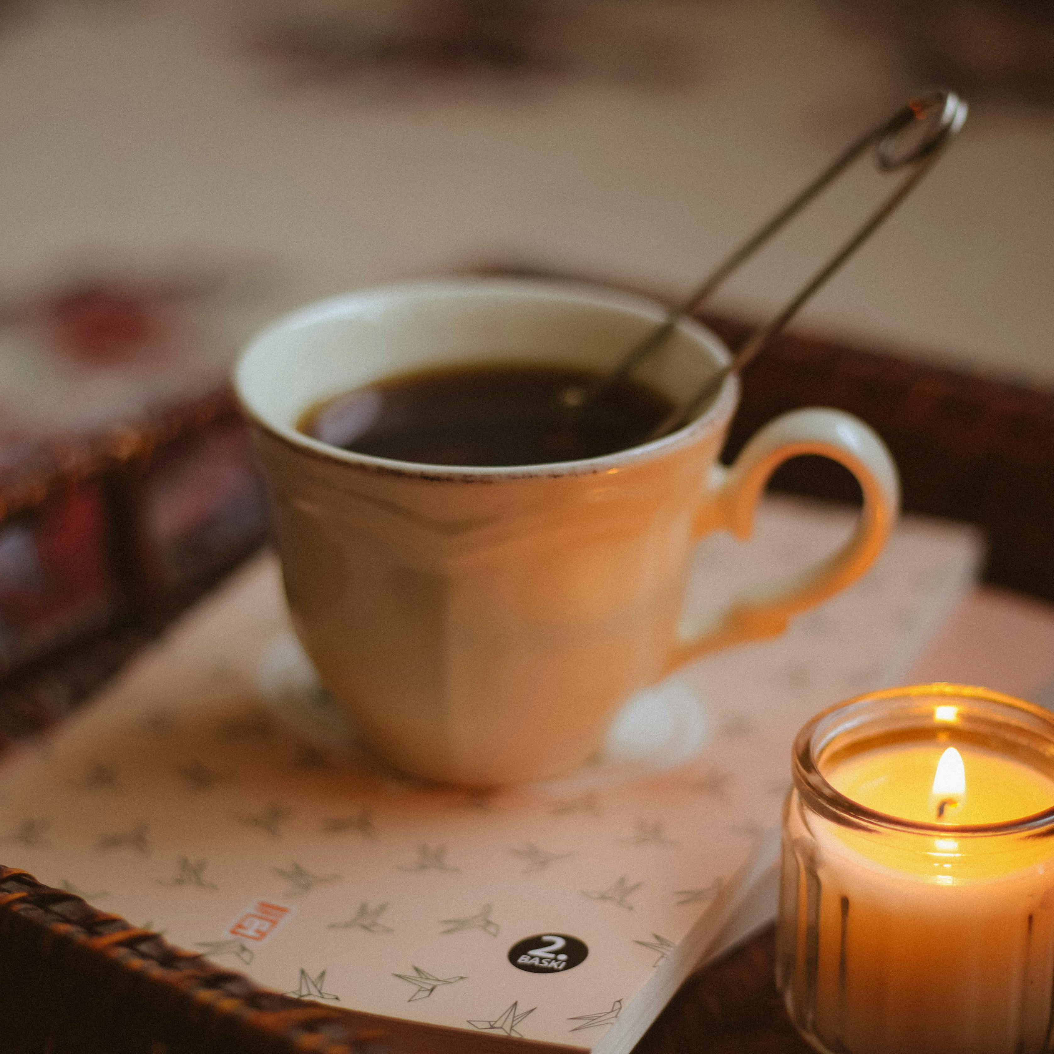 Cup of Drink Beside Lighted Candles · Free Stock Photo