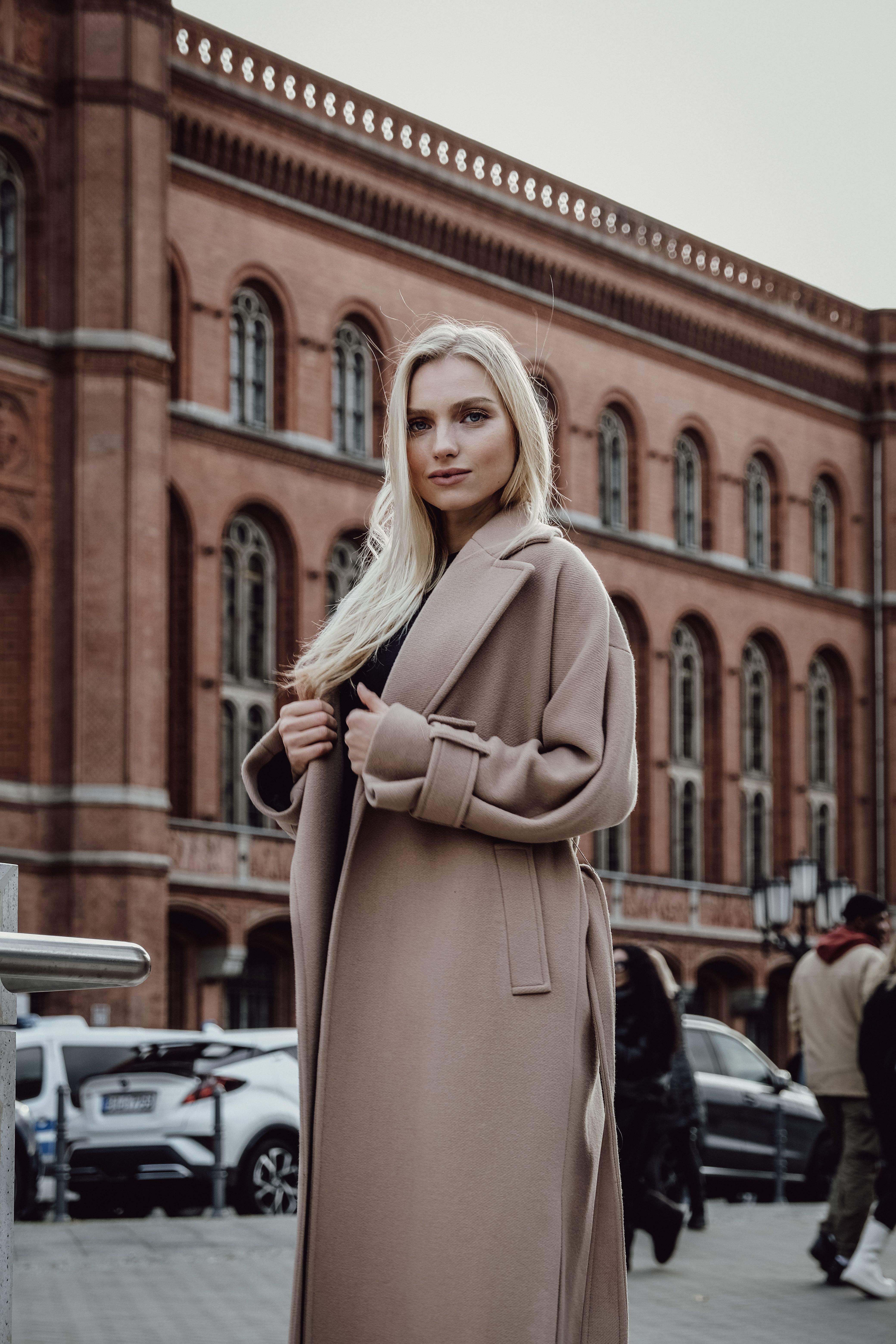 Person Posing on Busy Street in Front of Red Brick Building · Free ...