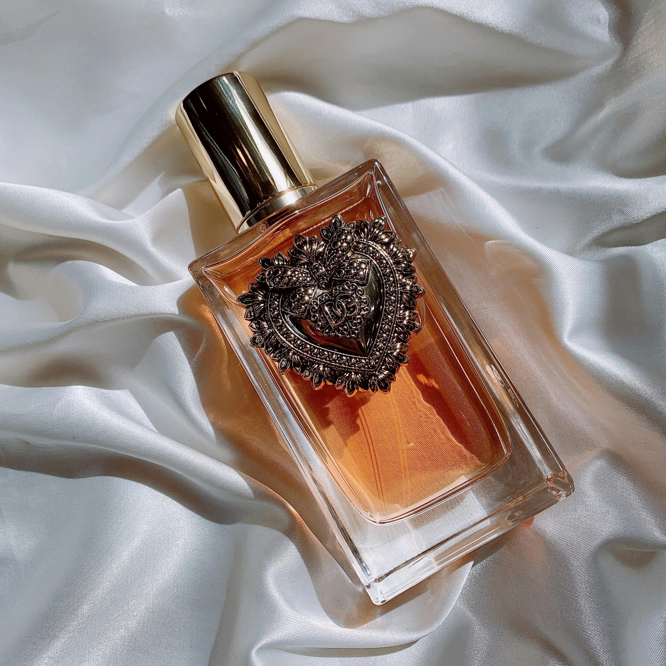 Decorative Bottle of Perfume Devotion from Dolce Gabbana on White Silk ...