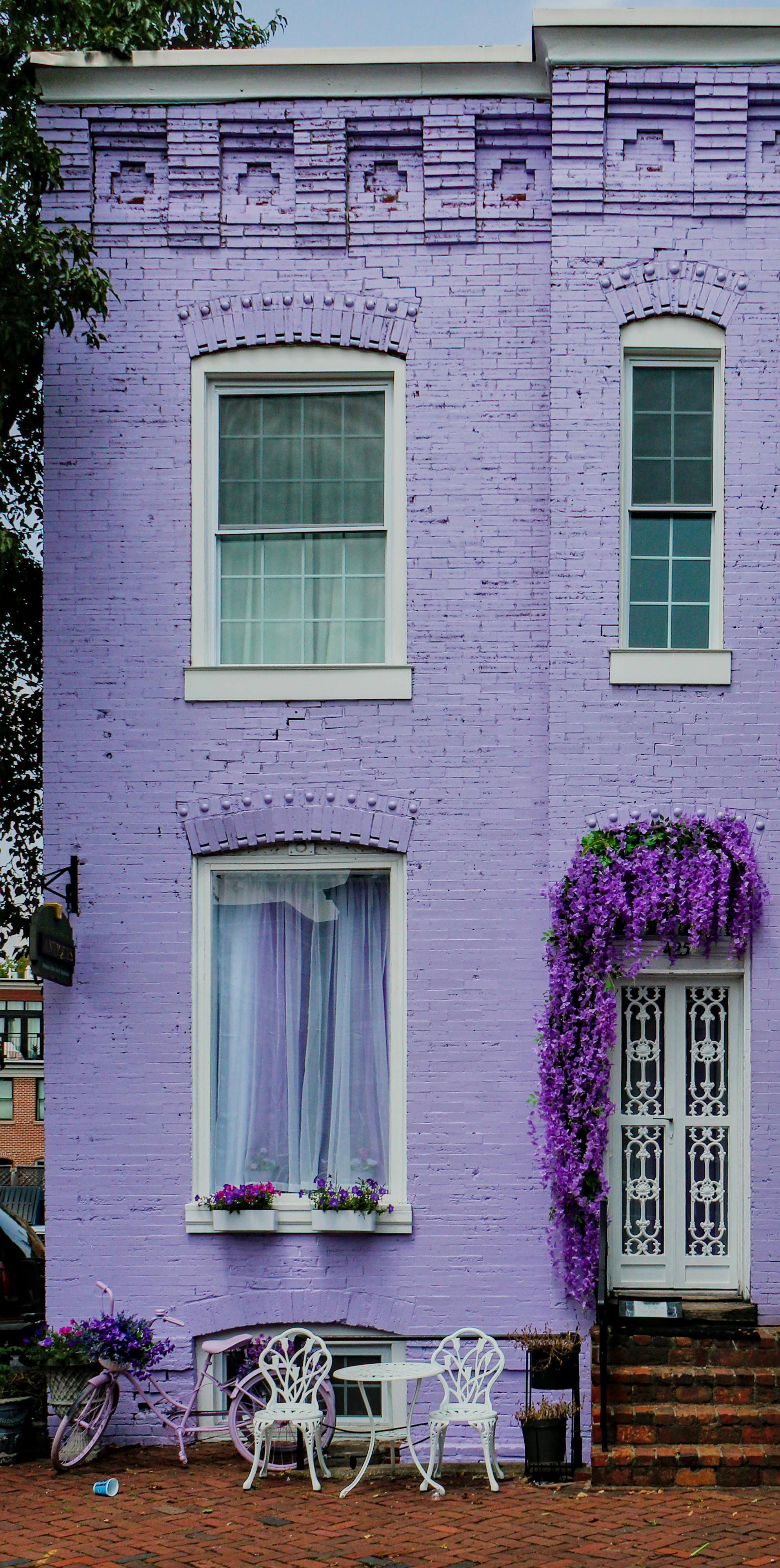 Purple Facade Decorated with Flowers · Free Stock Photo