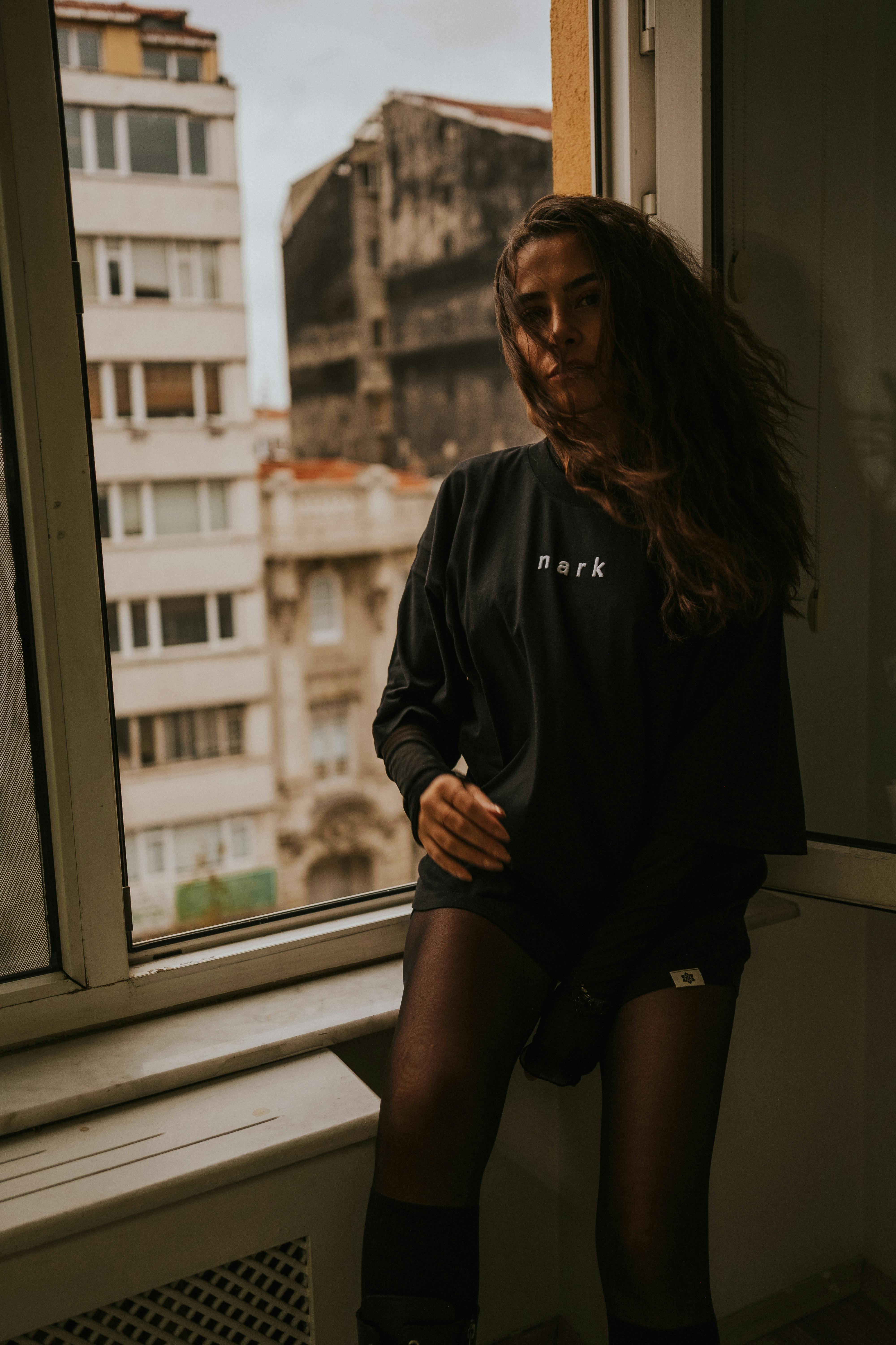 Woman Sitting in a Window · Free Stock Photo