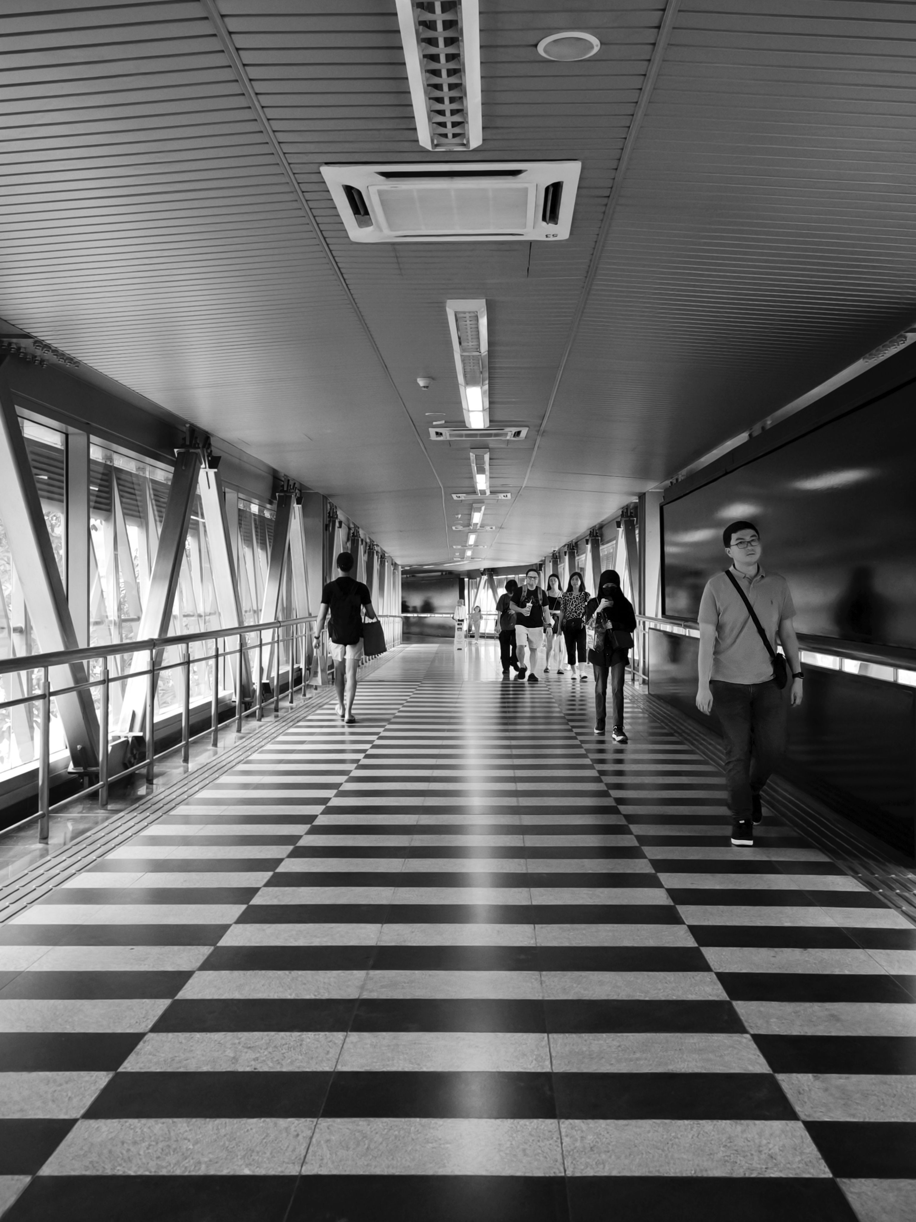 People Walking on Corridor with Pattern on Floor · Free Stock Photo
