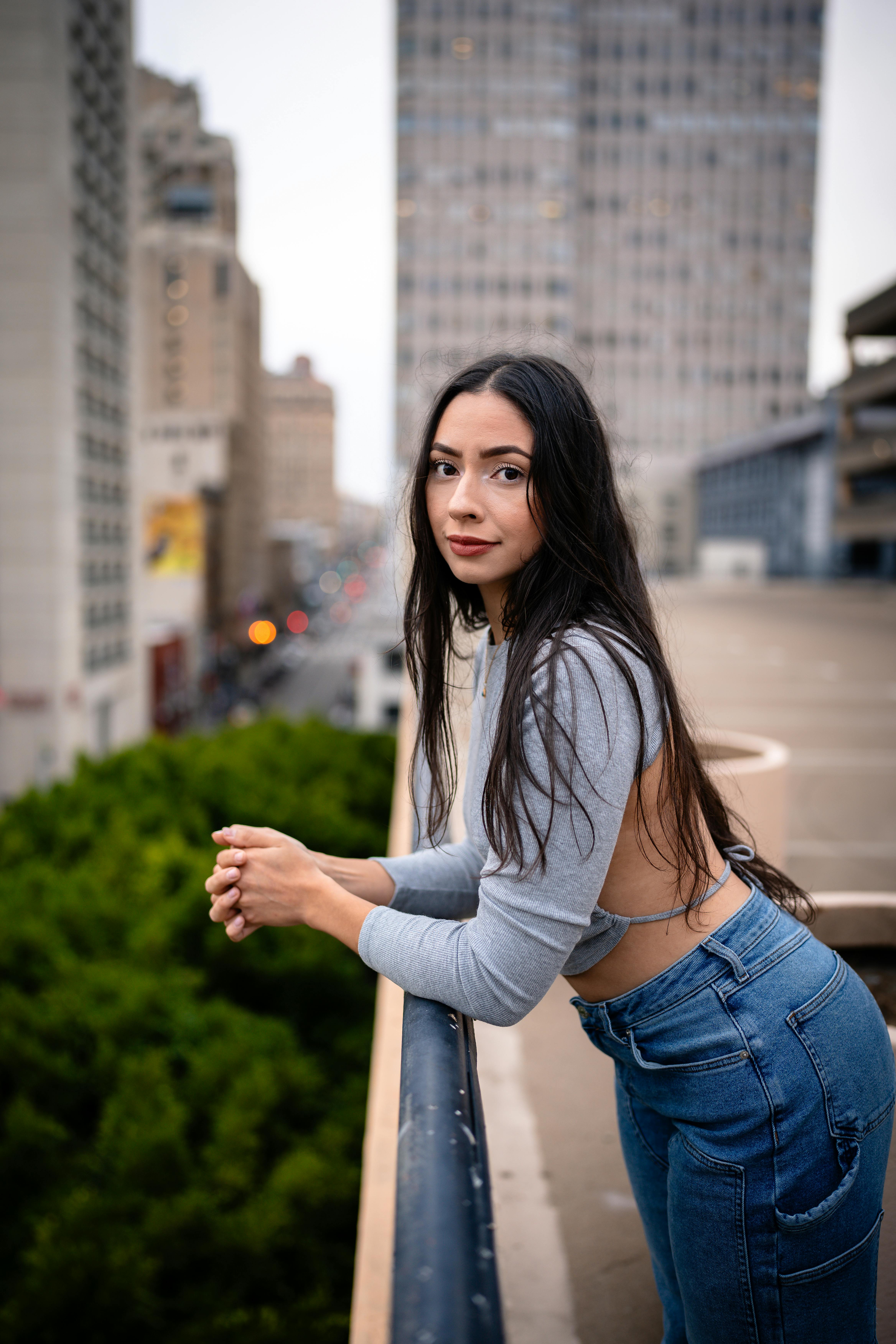 Woman with Black Hair Leaning on Railing · Free Stock Photo