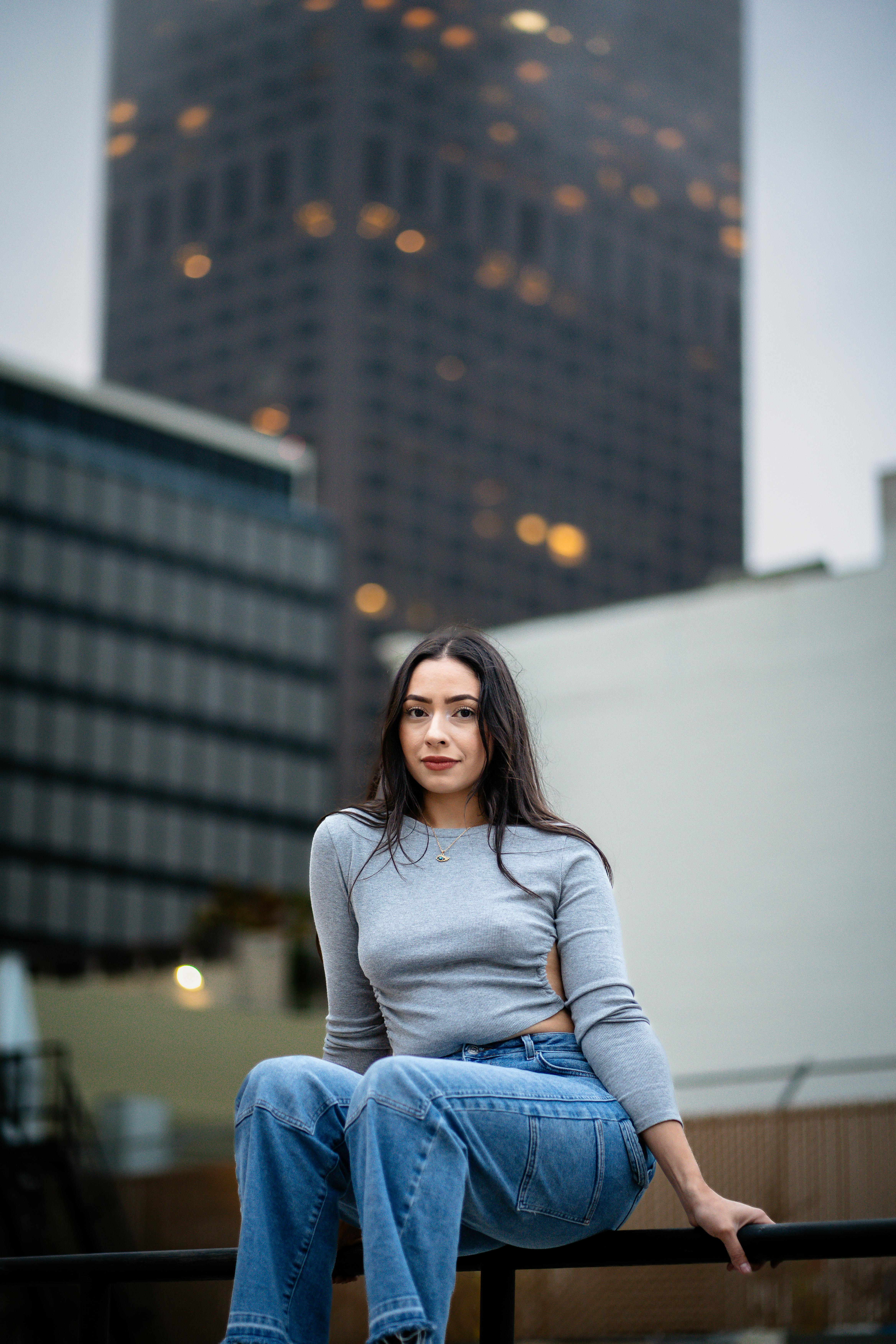 Woman Sitting on Railing · Free Stock Photo