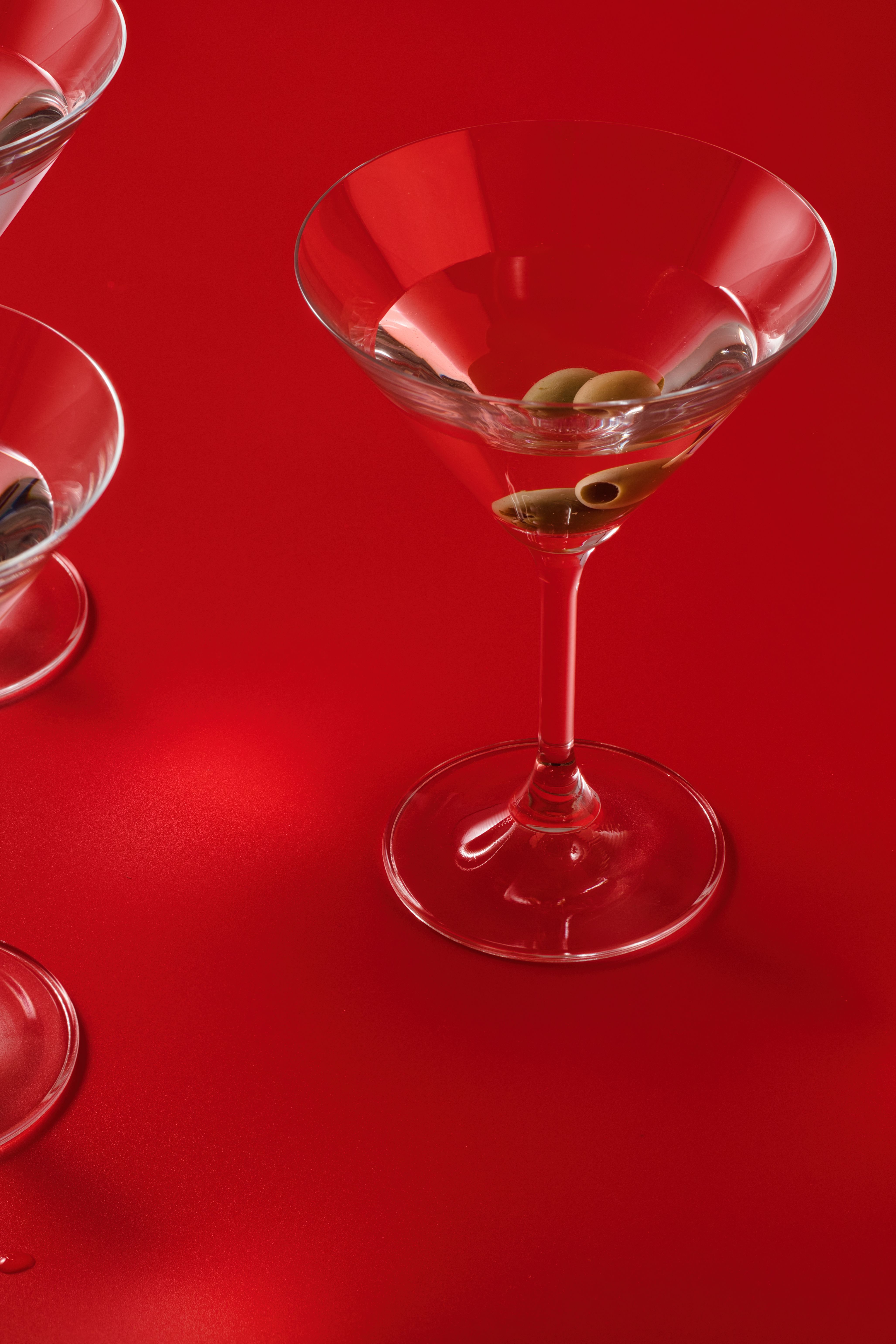Glass of Martini with Green Olives on a Red Table · Free Stock Photo