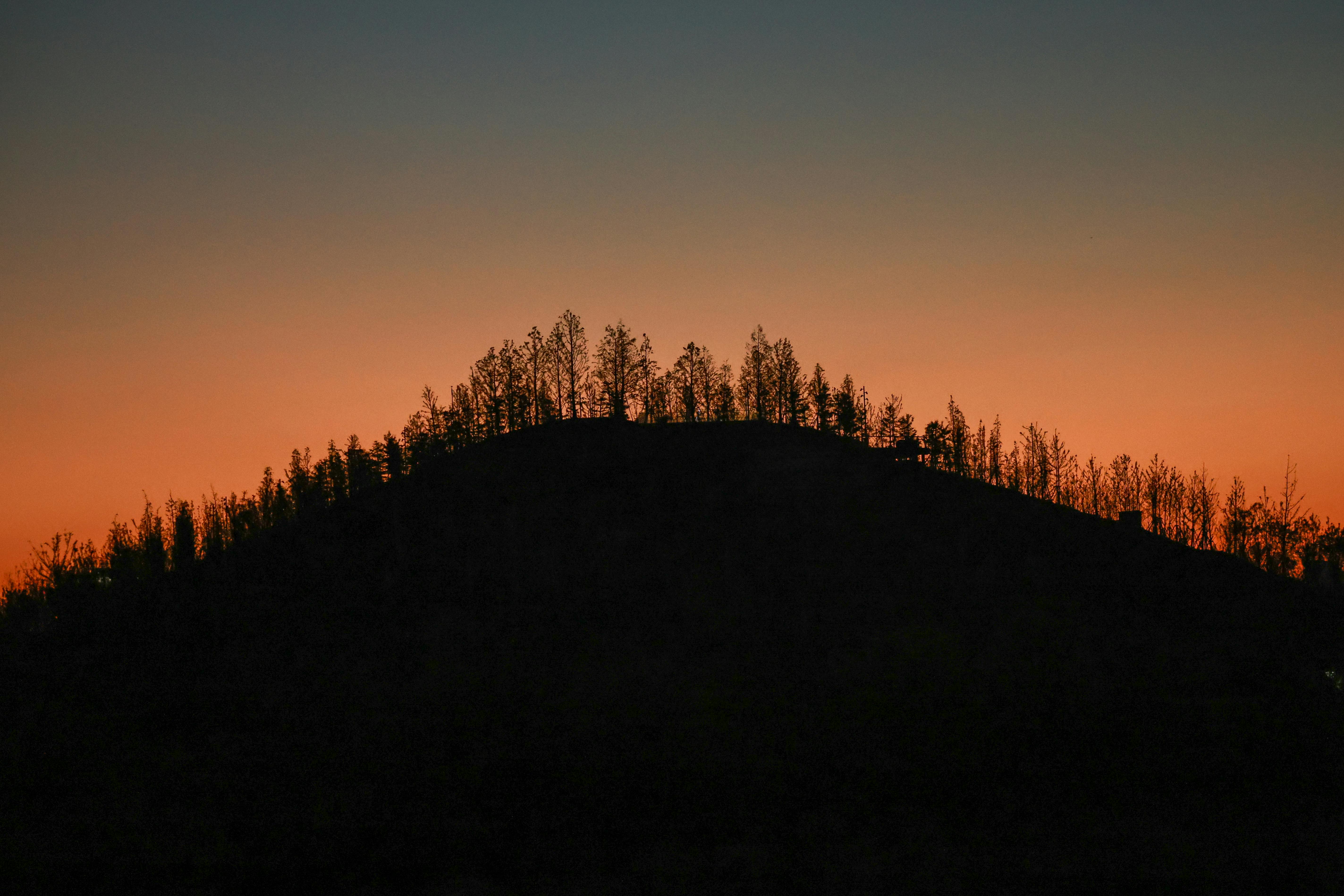 Silhouette of Hill at Sunset · Free Stock Photo