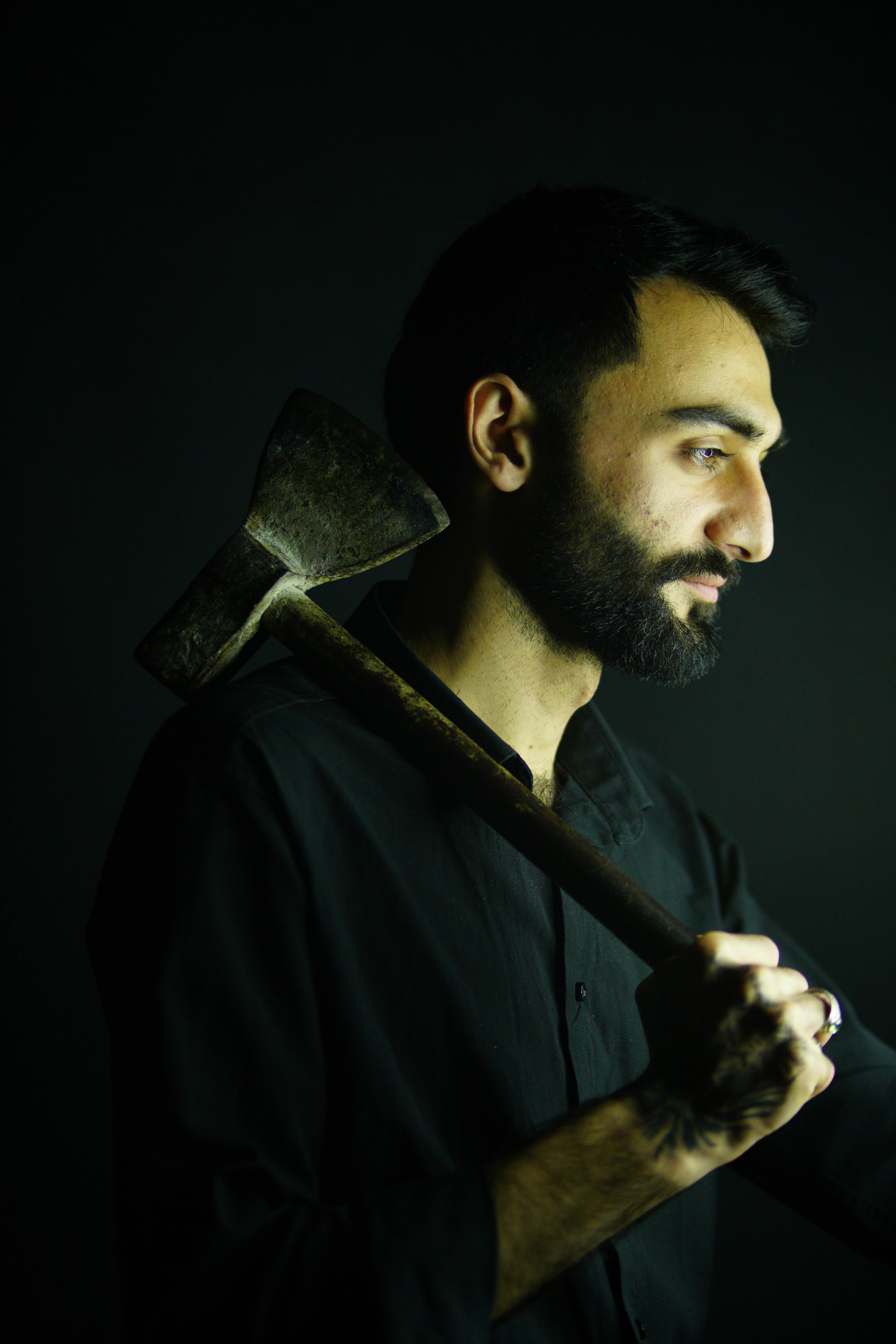 Portrait of a Man Holding an Axe · Free Stock Photo