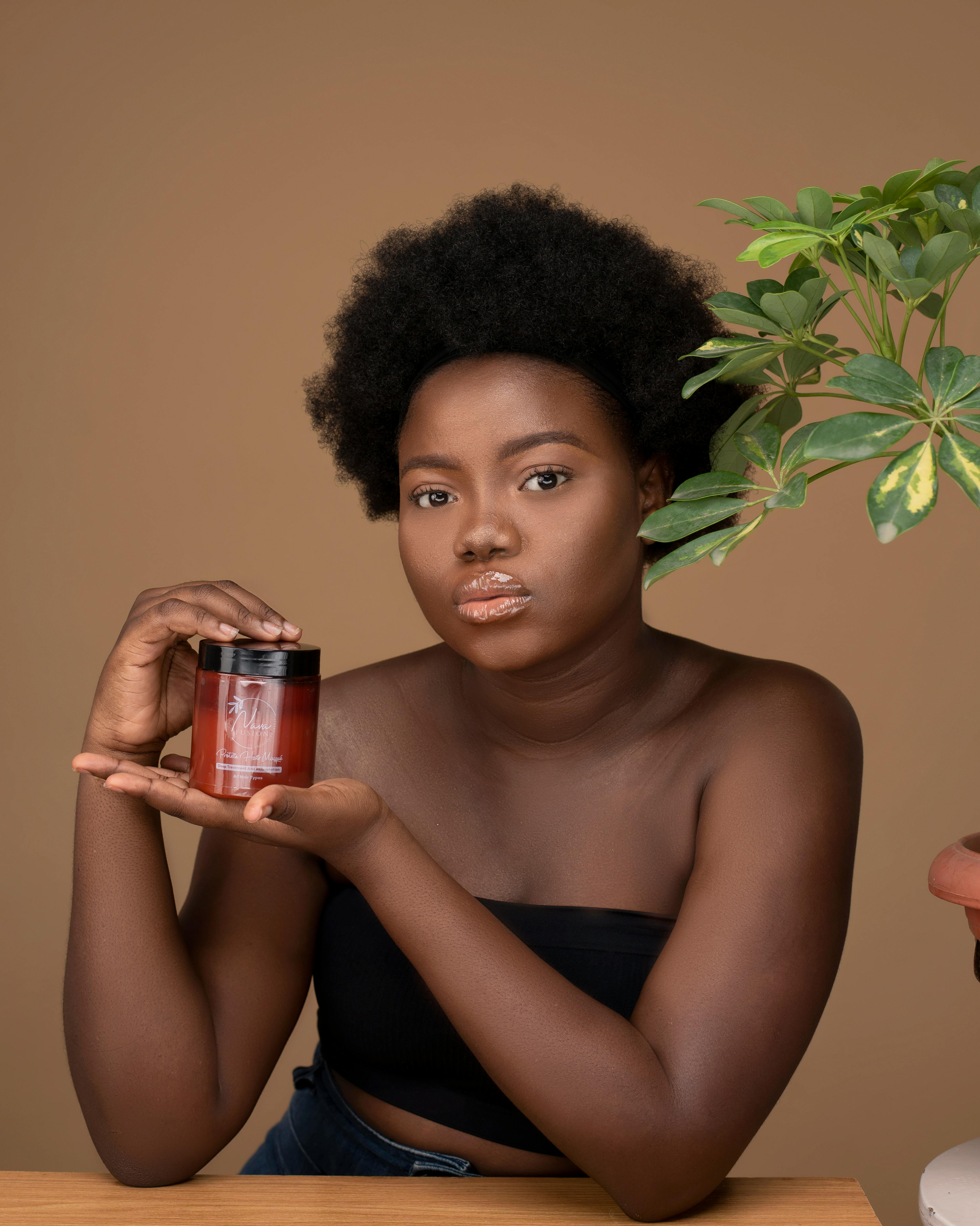 Model Presenting a Jar of Cream · Free Stock Photo