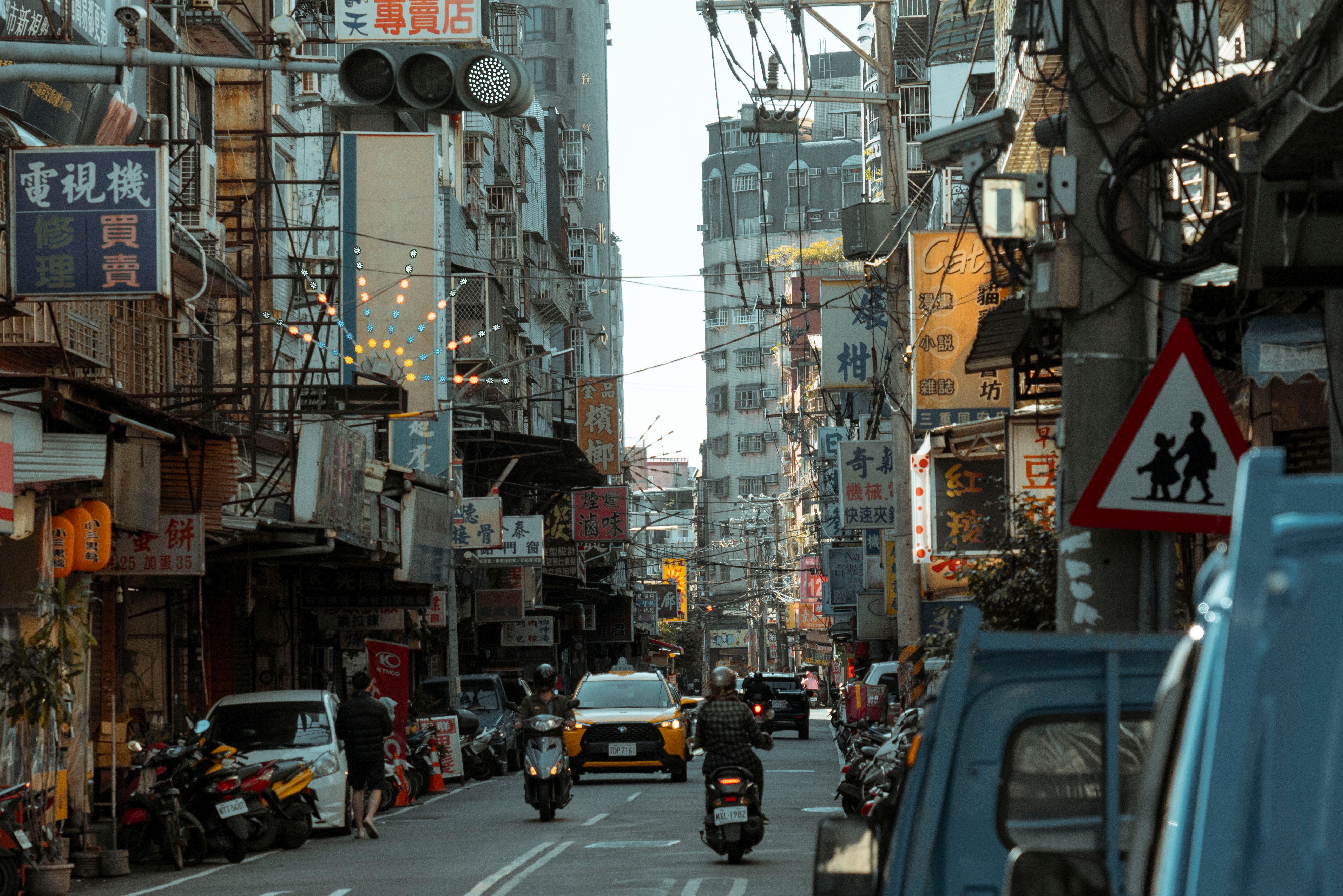 Cars and Scooters on a Narrow Street in Asia · Free Stock Photo