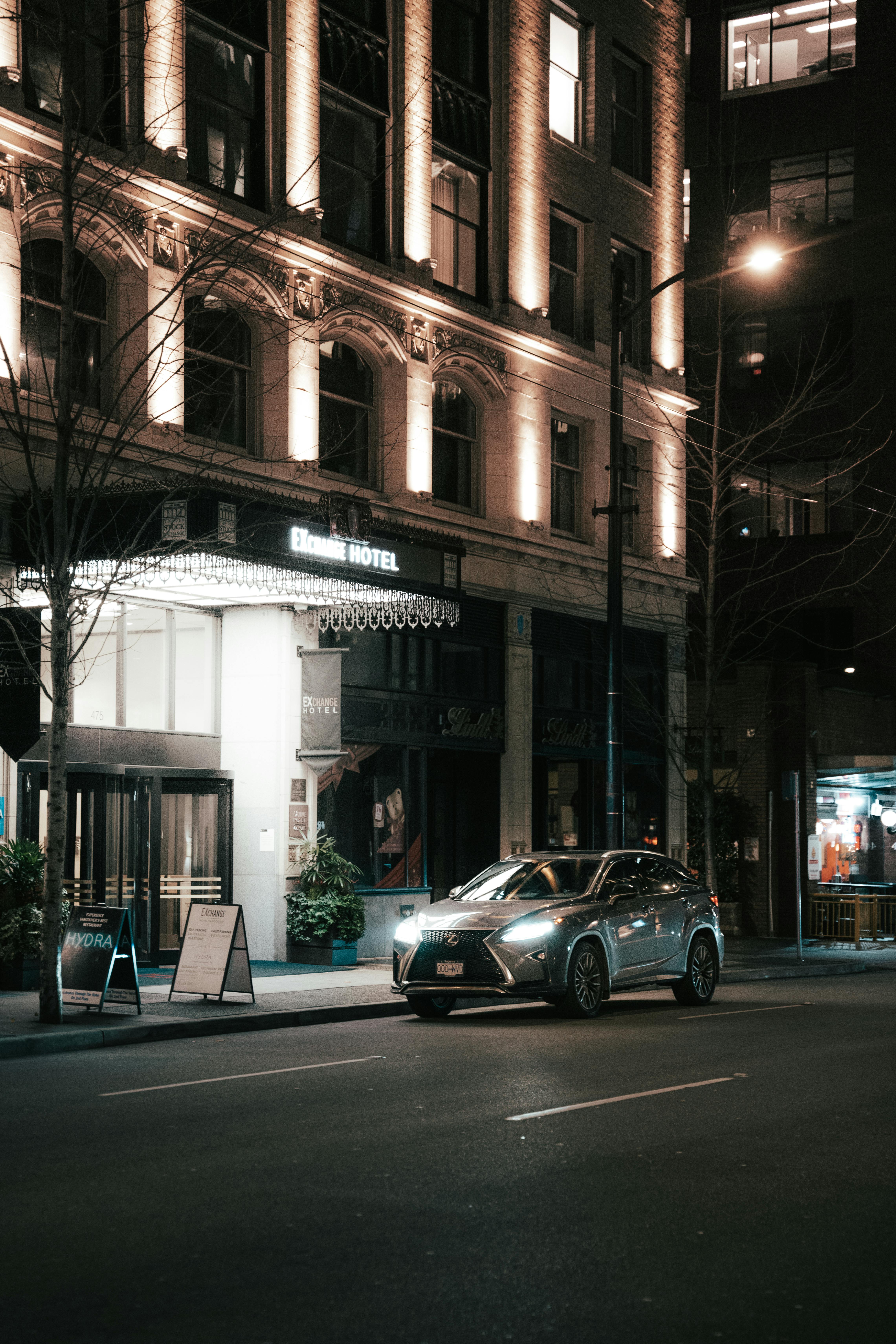 Lexus RX Parked in Front of the Hotel Entrance at Night · Free Stock Photo