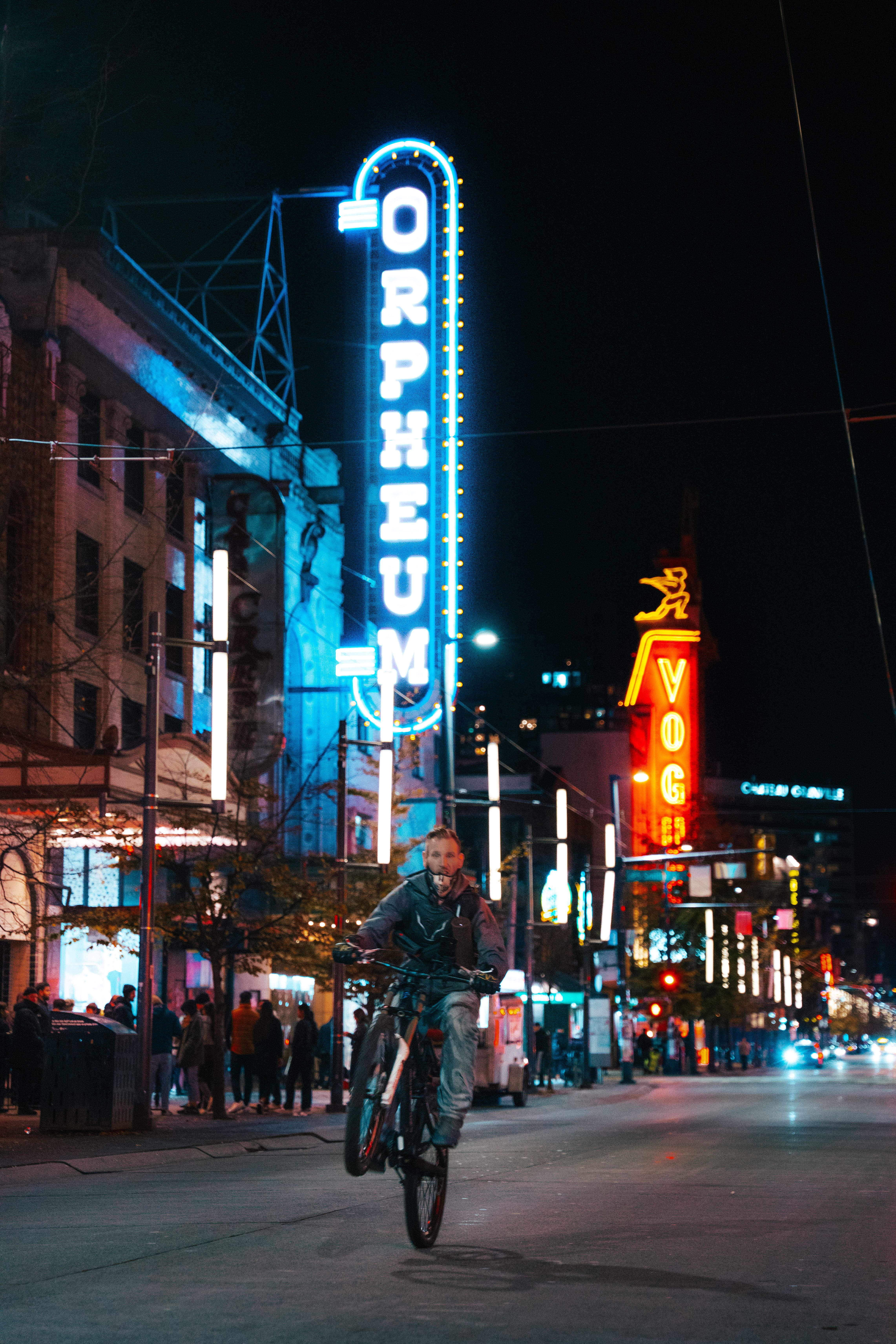 Man Riding on One Wheel on Bike on Street at Night · Free Stock Photo
