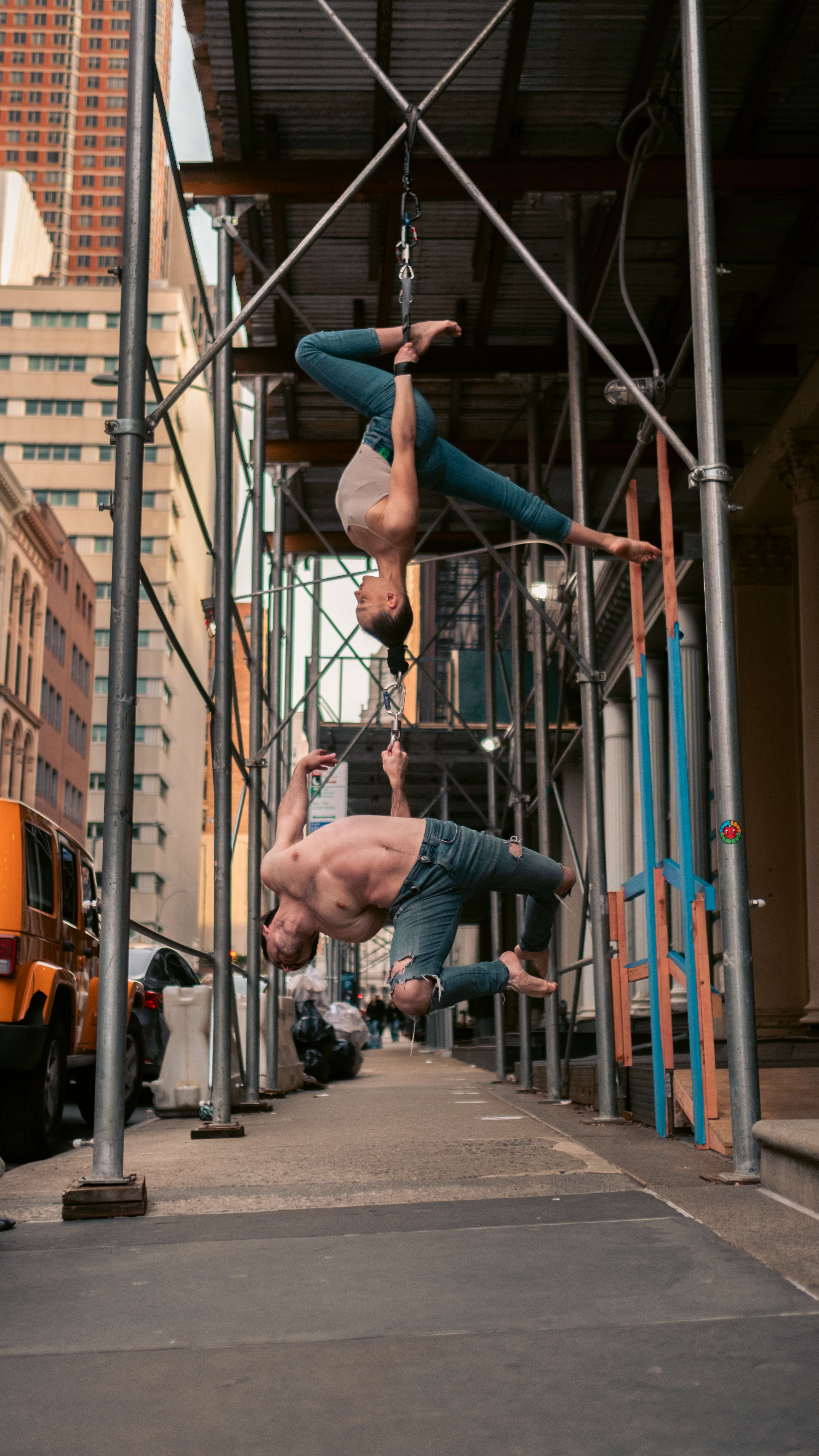 Acrobats Hanging on Scaffolding on Sidewalk · Free Stock Photo