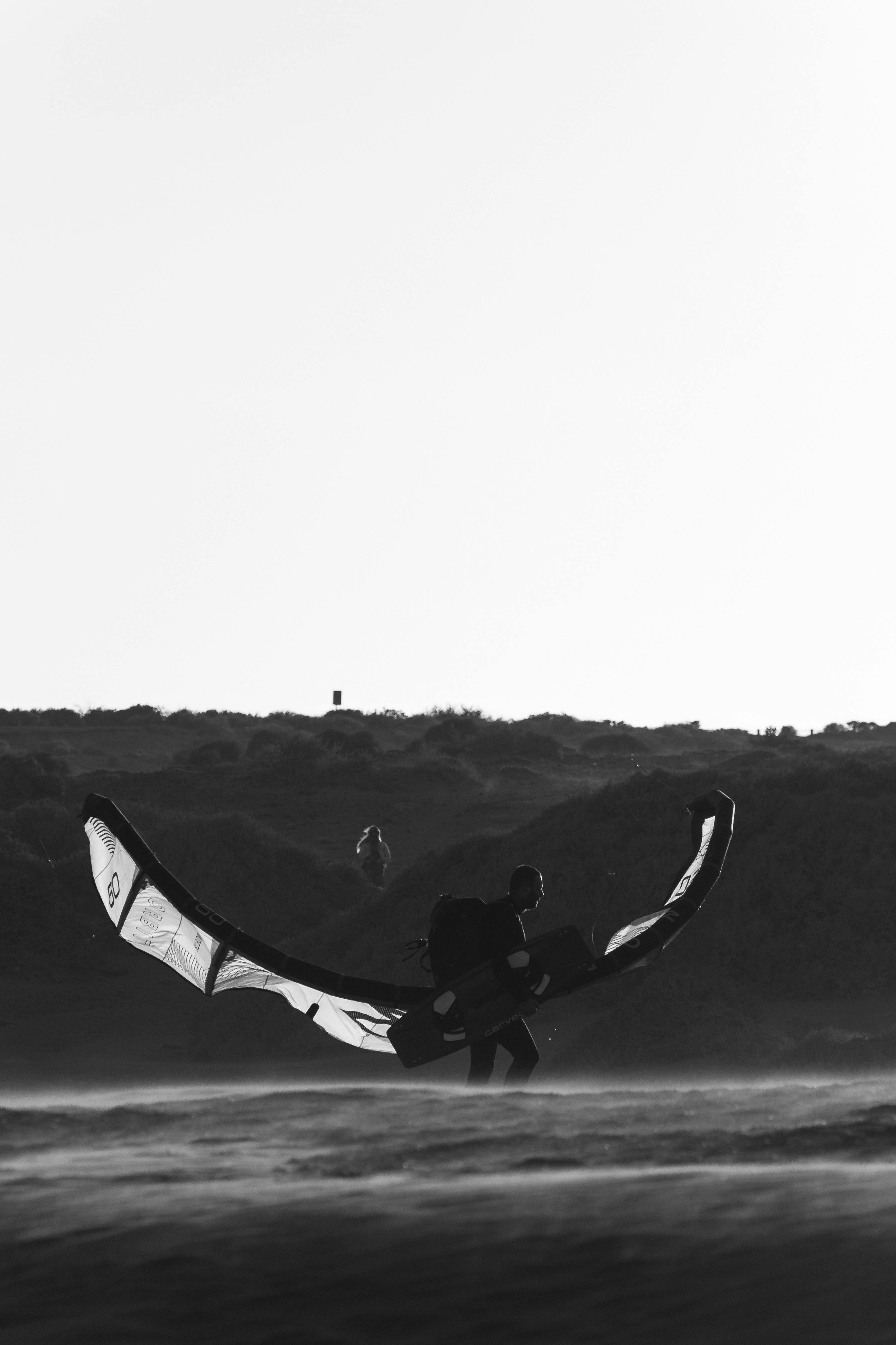 Man Carrying Kitesurfing Equipment · Free Stock Photo