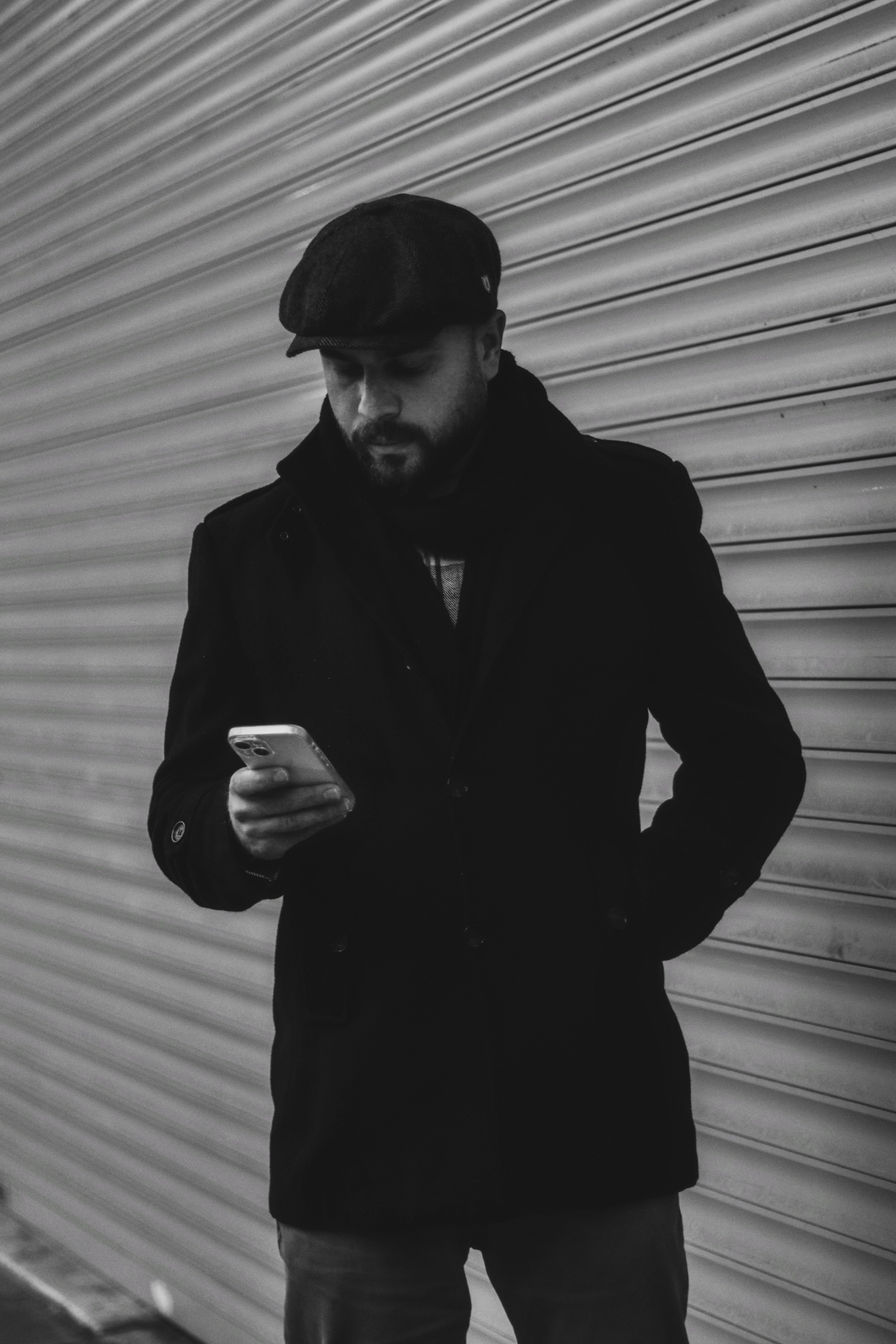 Man Standing and Looking at his Smartphone · Free Stock Photo