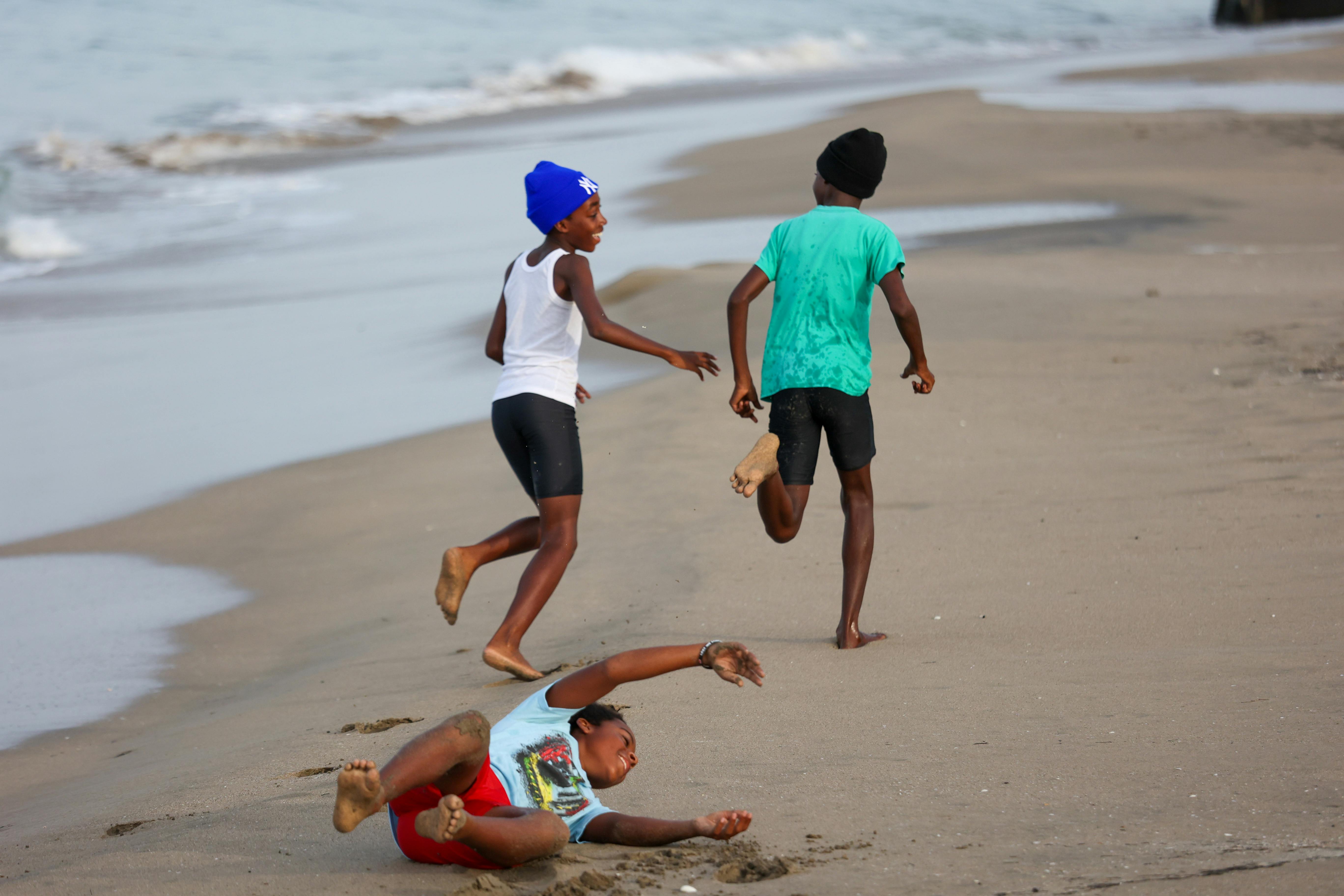 Kids Throwing Sand on Each Other · Free Stock Photo