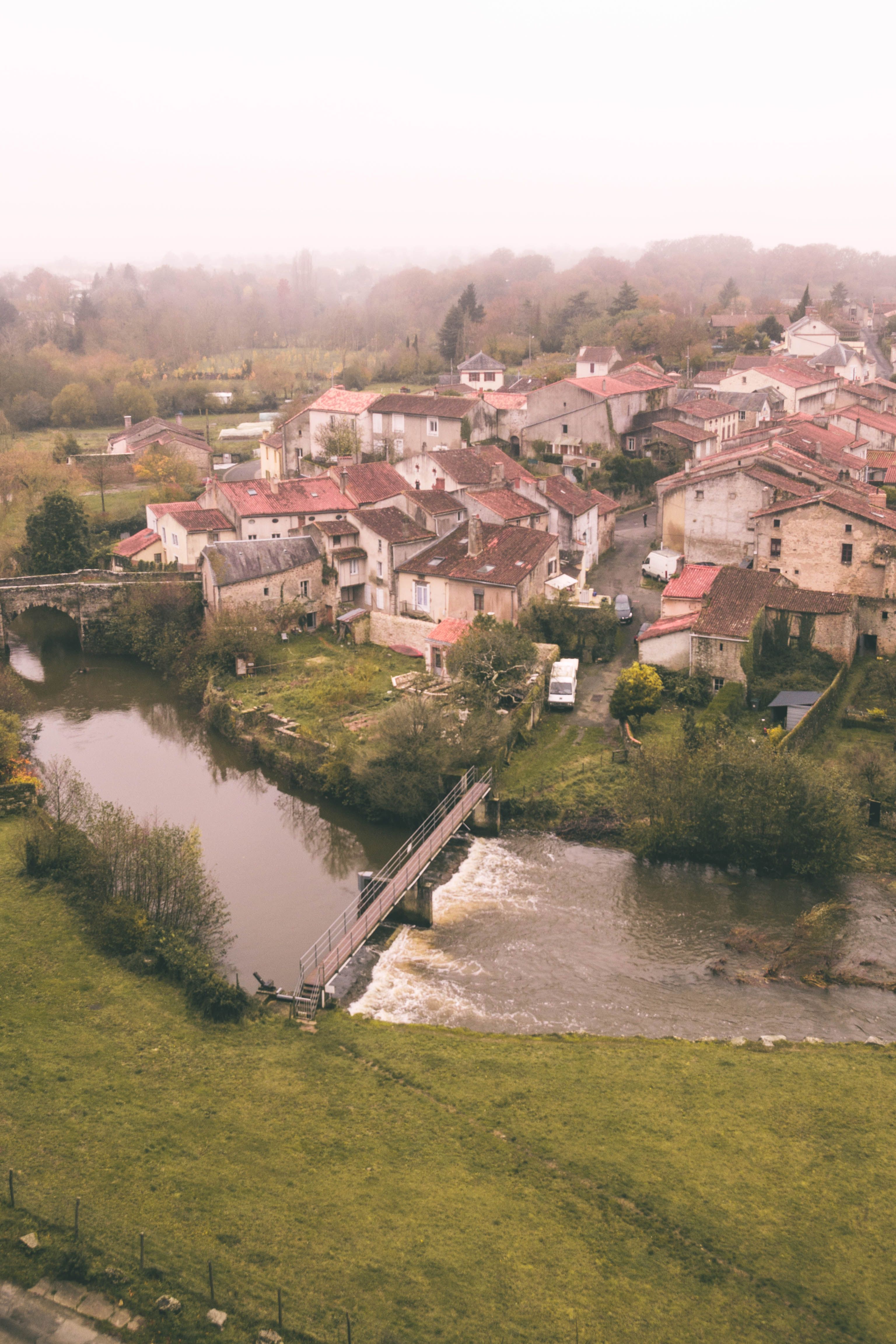 River and Town Buildings behind · Free Stock Photo