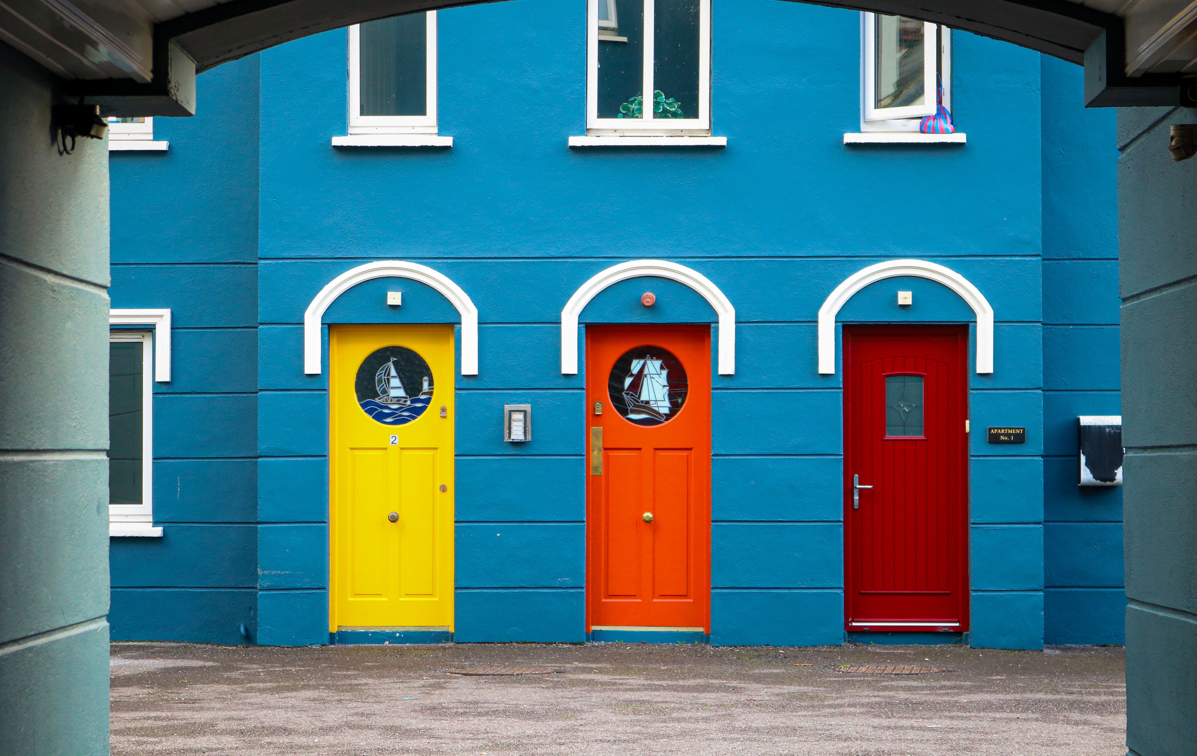 Building Facade with Colorful Entrance Doors · Free Stock Photo