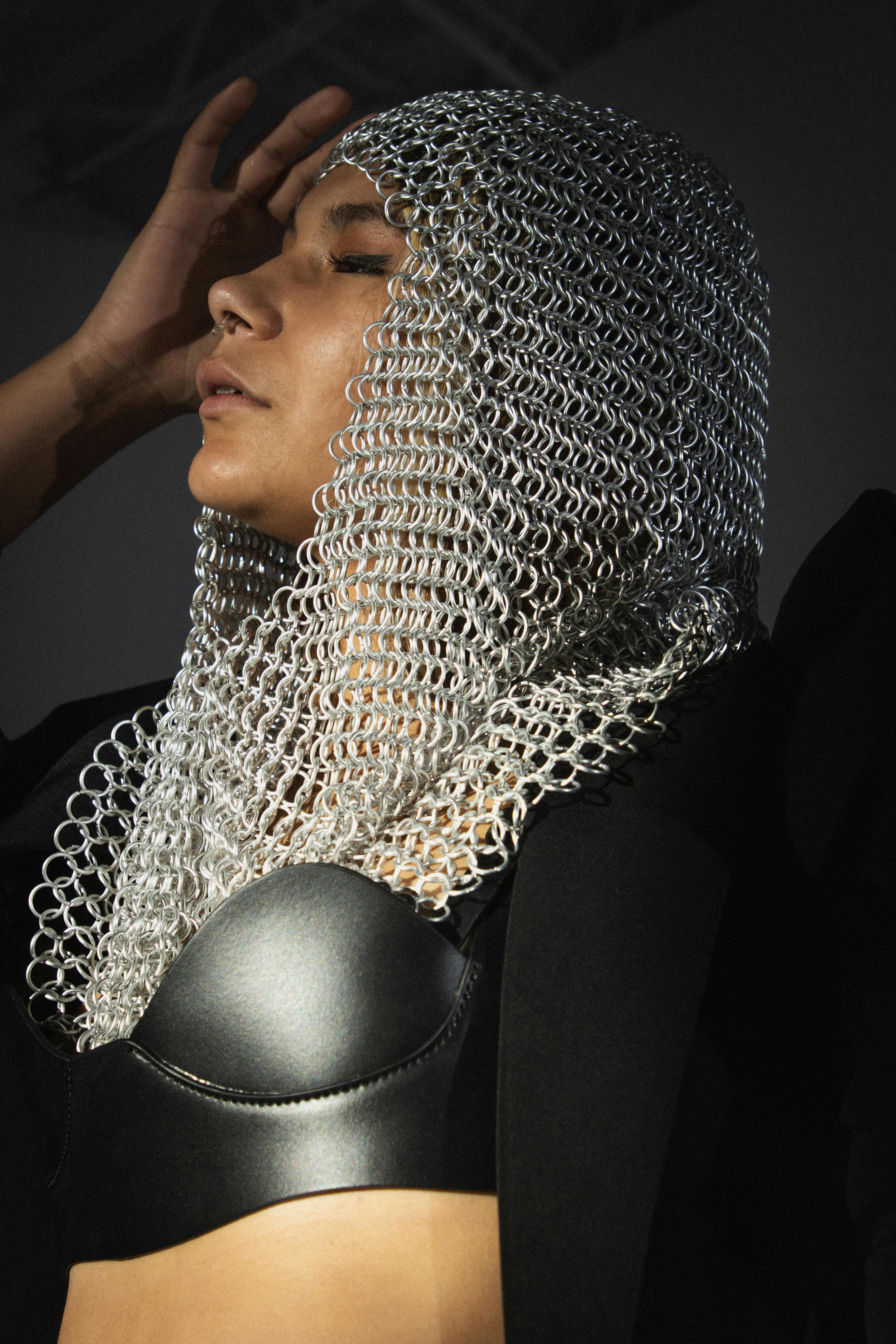 Model in a Chainmail Cap and Leather Bra · Free Stock Photo