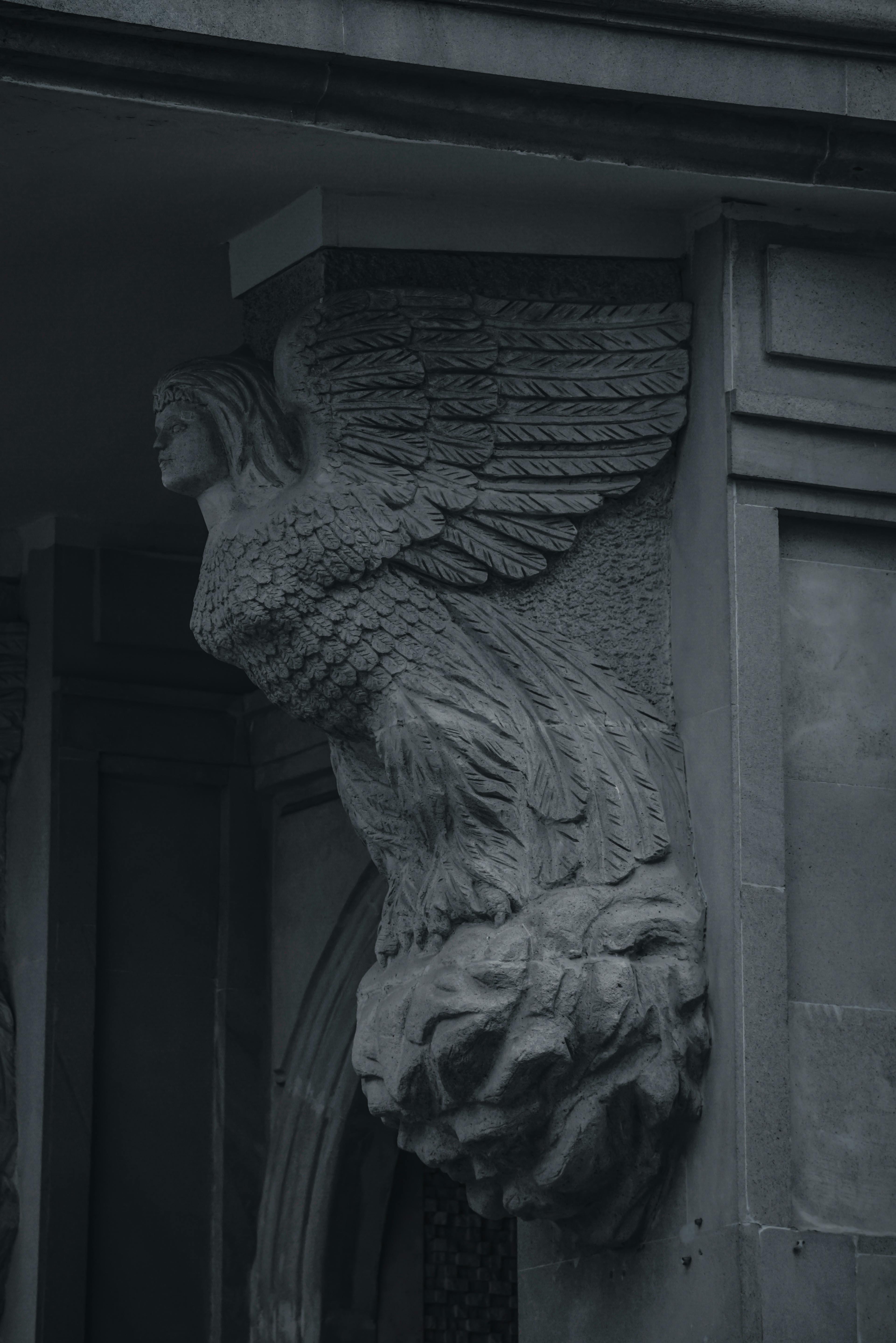 Relief of Woman atop Column Supporting Wall · Free Stock Photo