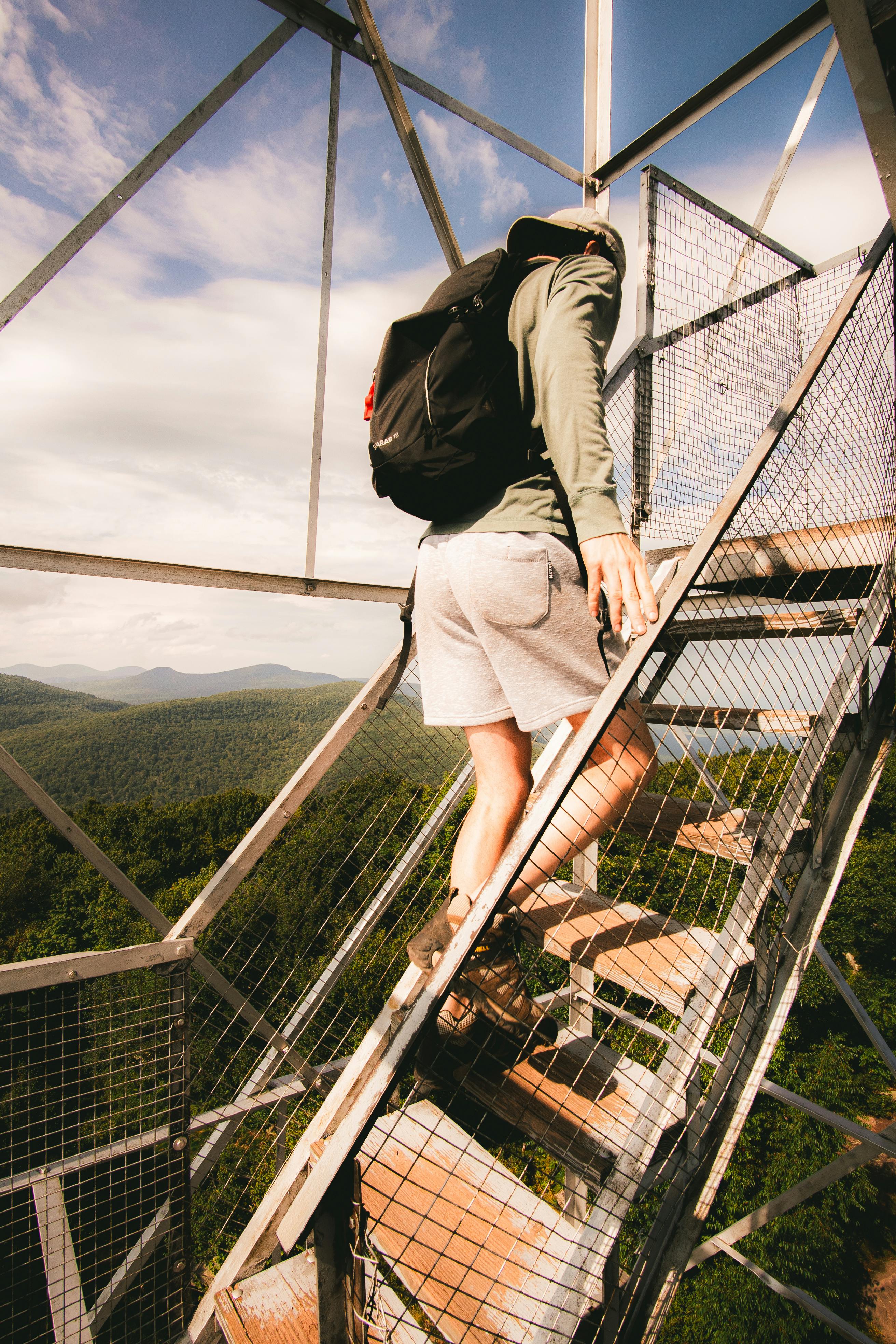 Man Climbing Tower in Forest · Free Stock Photo