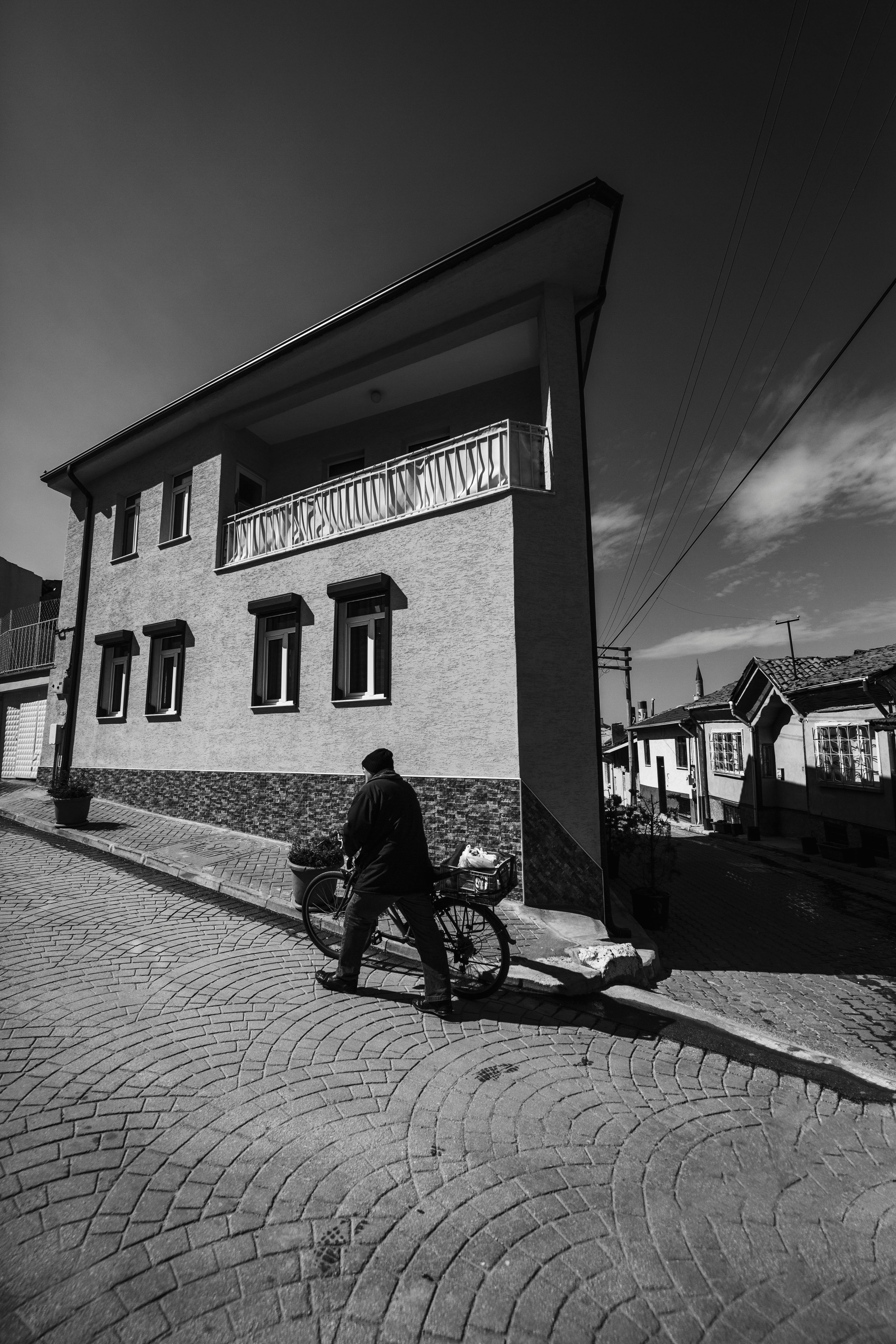 Passerby Walking With a Bicycle Past a House at an Intersection · Free ...