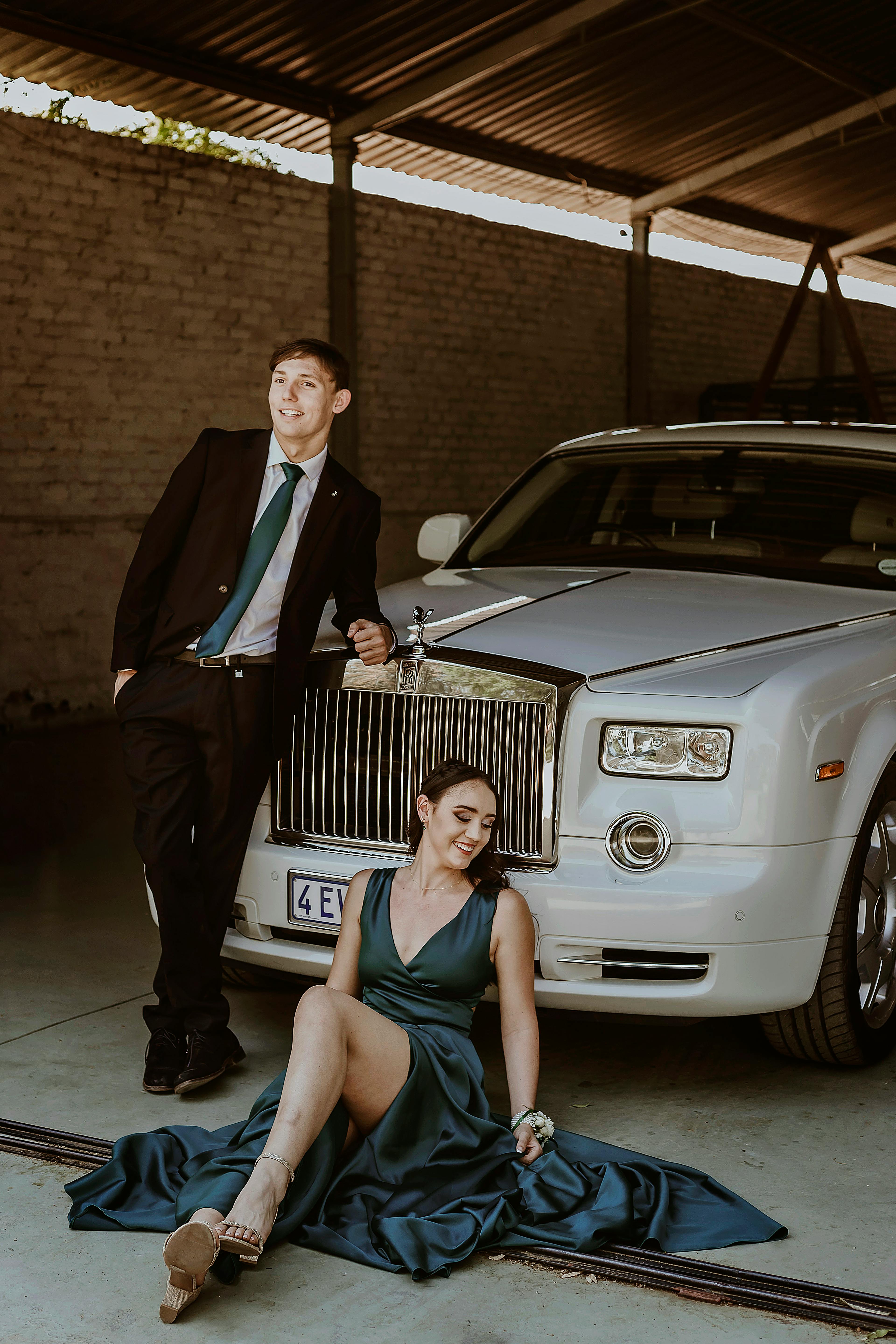 Two People Posing by a Car · Free Stock Photo