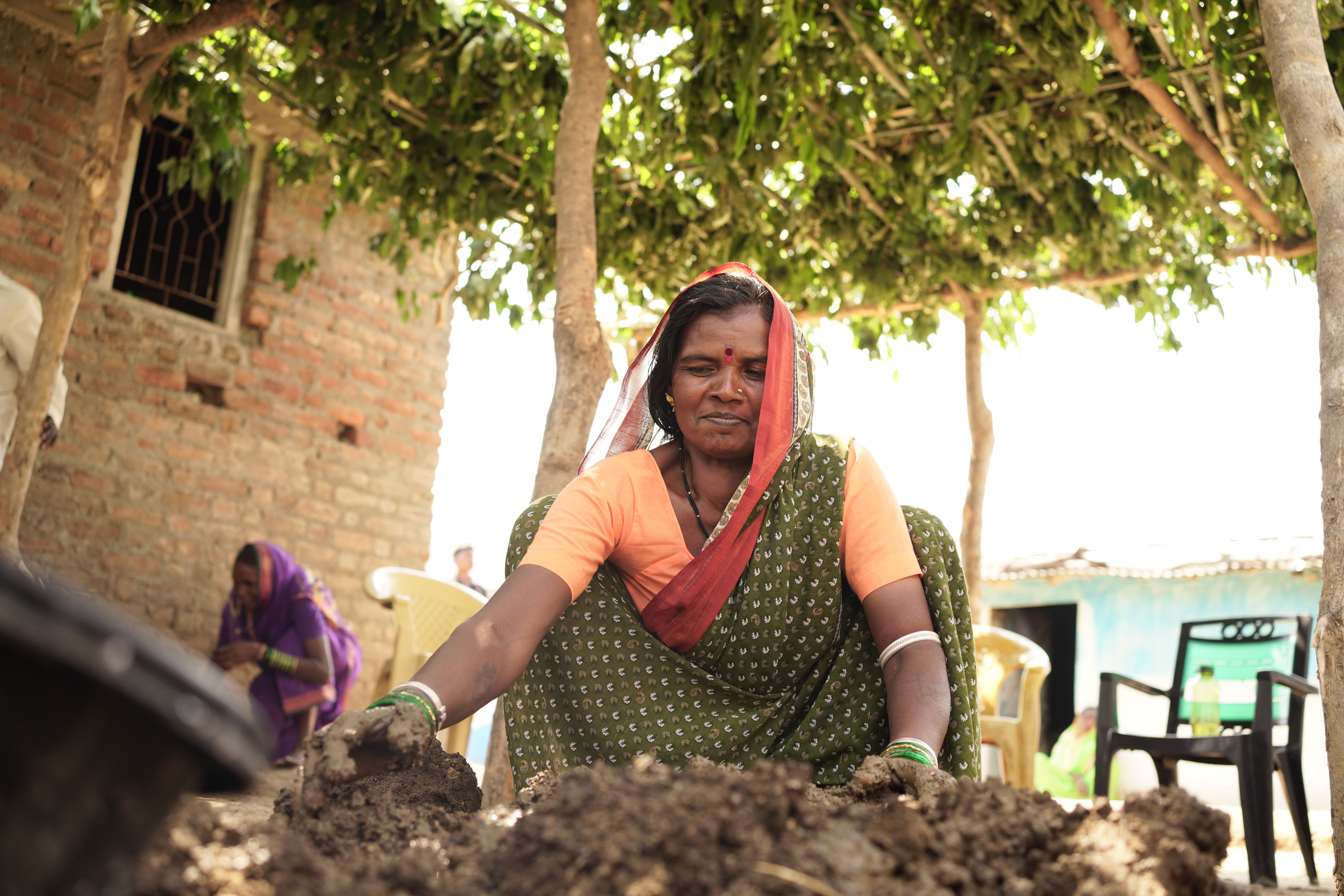 Indian Woman in Traditional Clothing Working in the Yard · Free Stock Photo