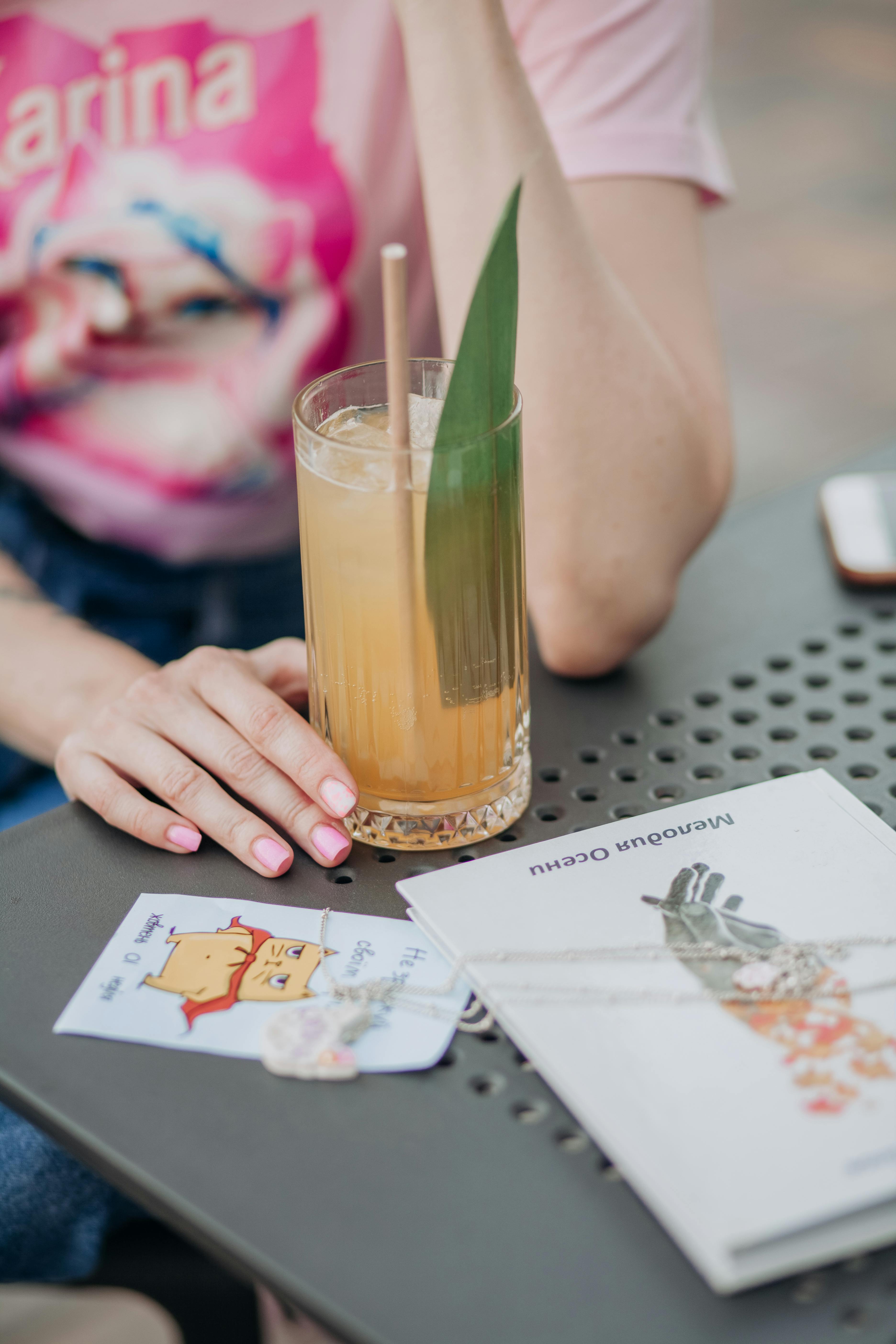 Woman Pulling Straw out of Glass of Thick Milk Tea · Free Stock Photo
