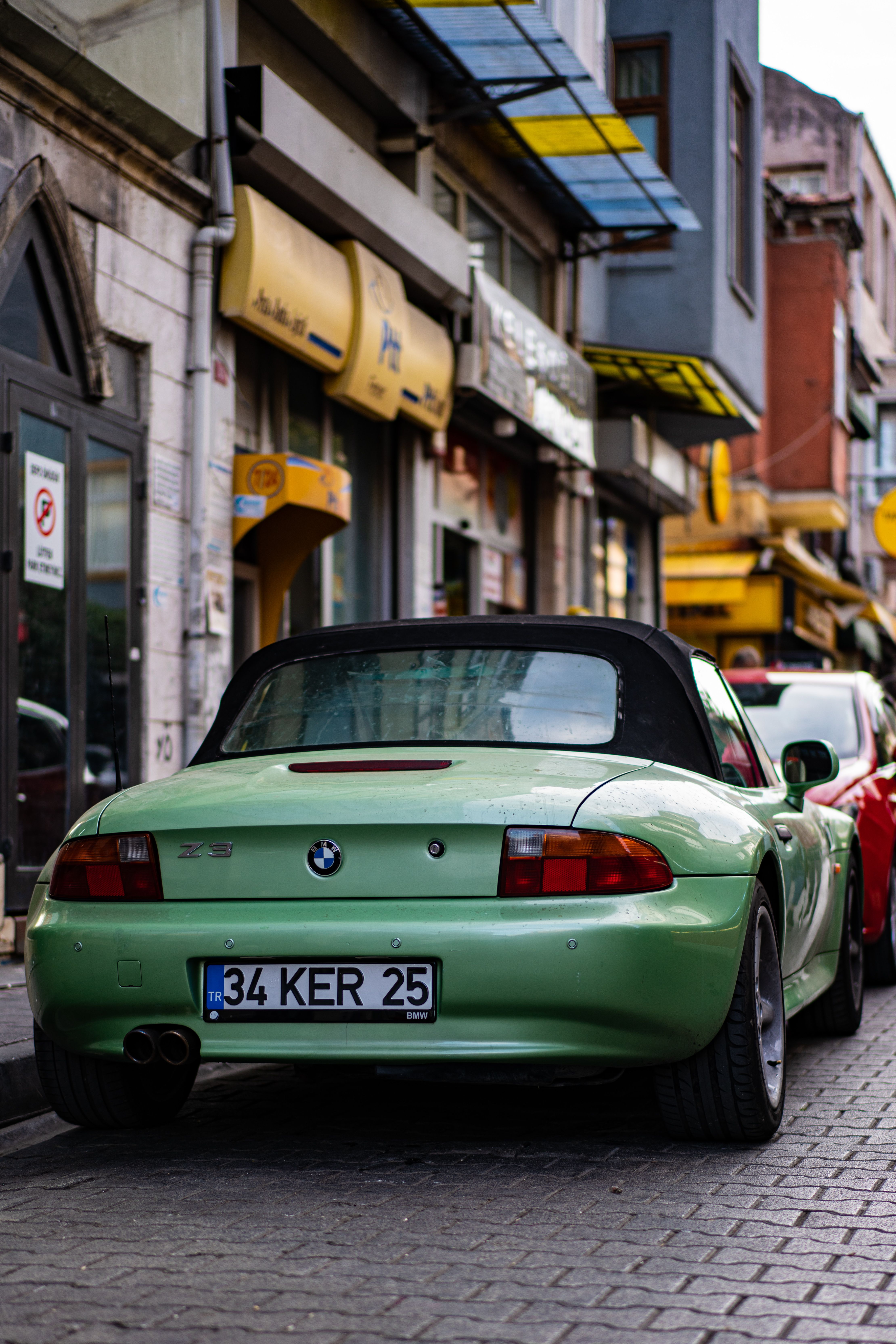 Back View of a Green Convertible Car Parked on a Street · Free Stock Photo