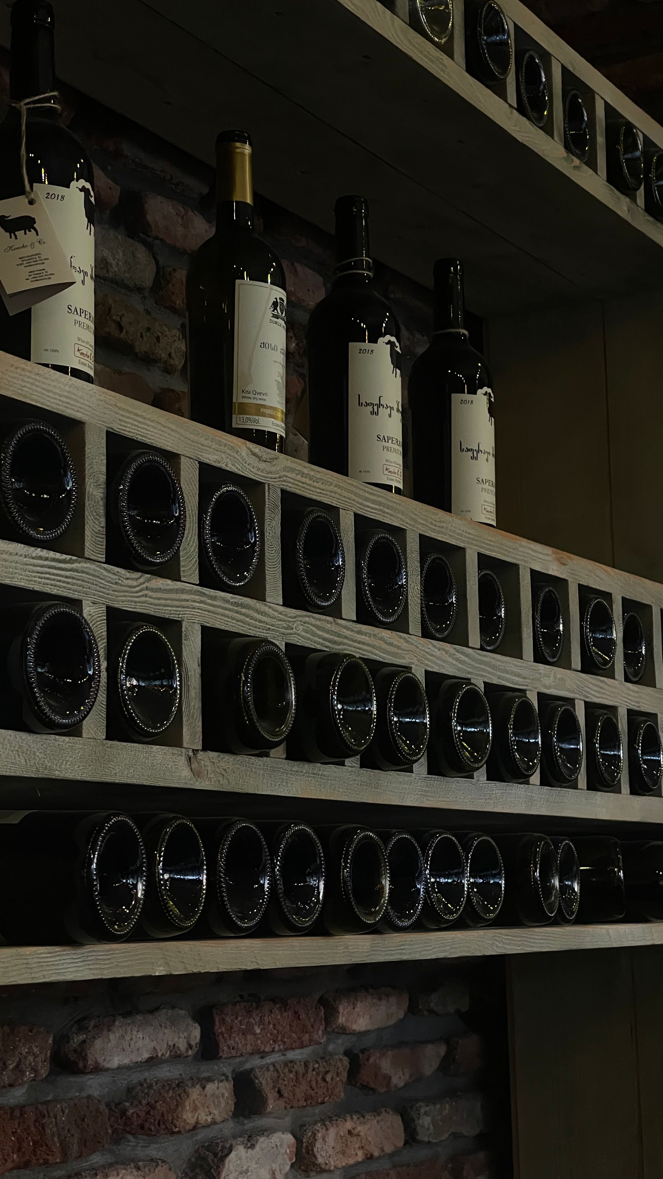 Wine Bottles on and in Shelves · Free Stock Photo