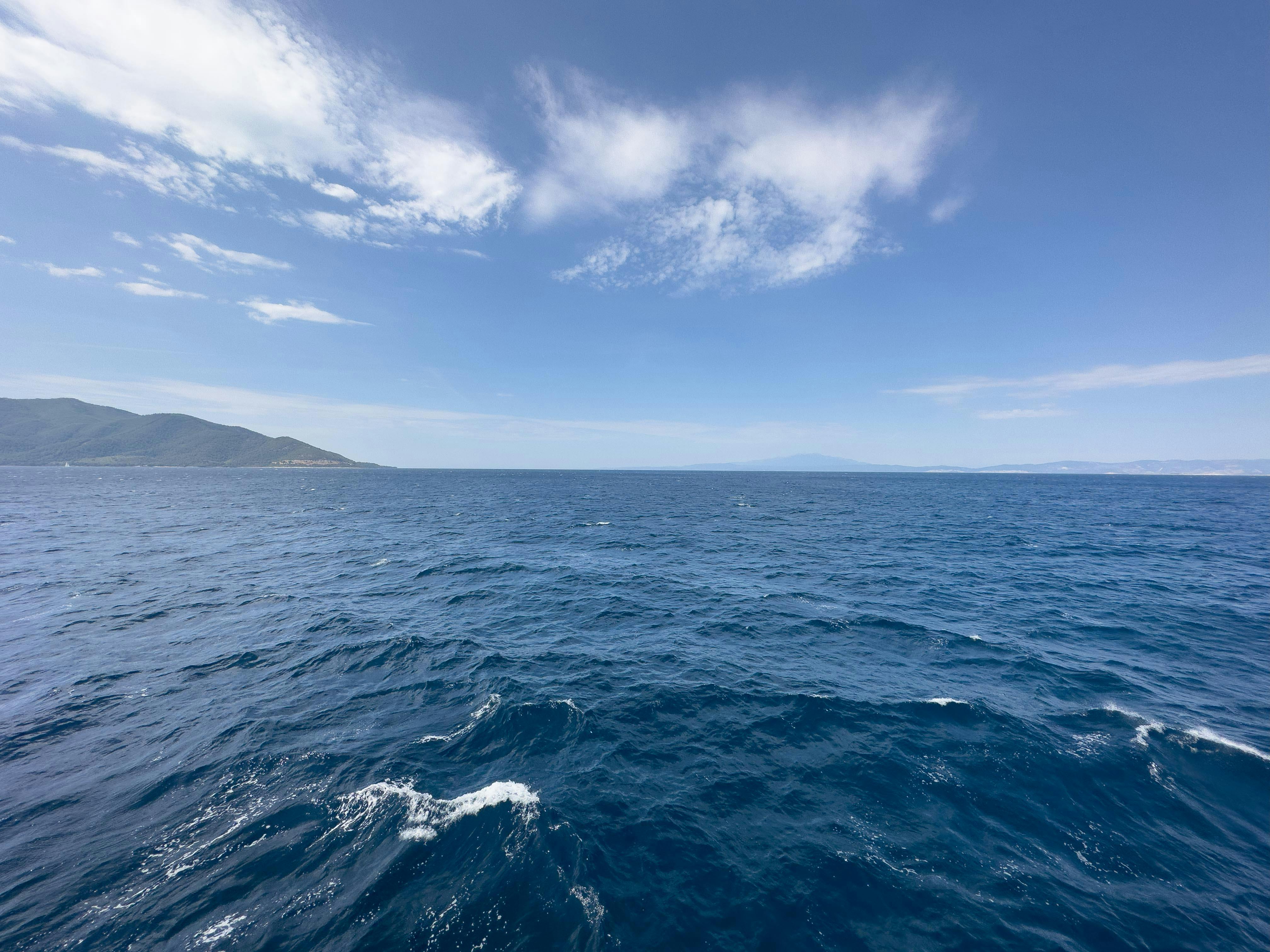 Blue Sky Over the Undulating Sea · Free Stock Photo