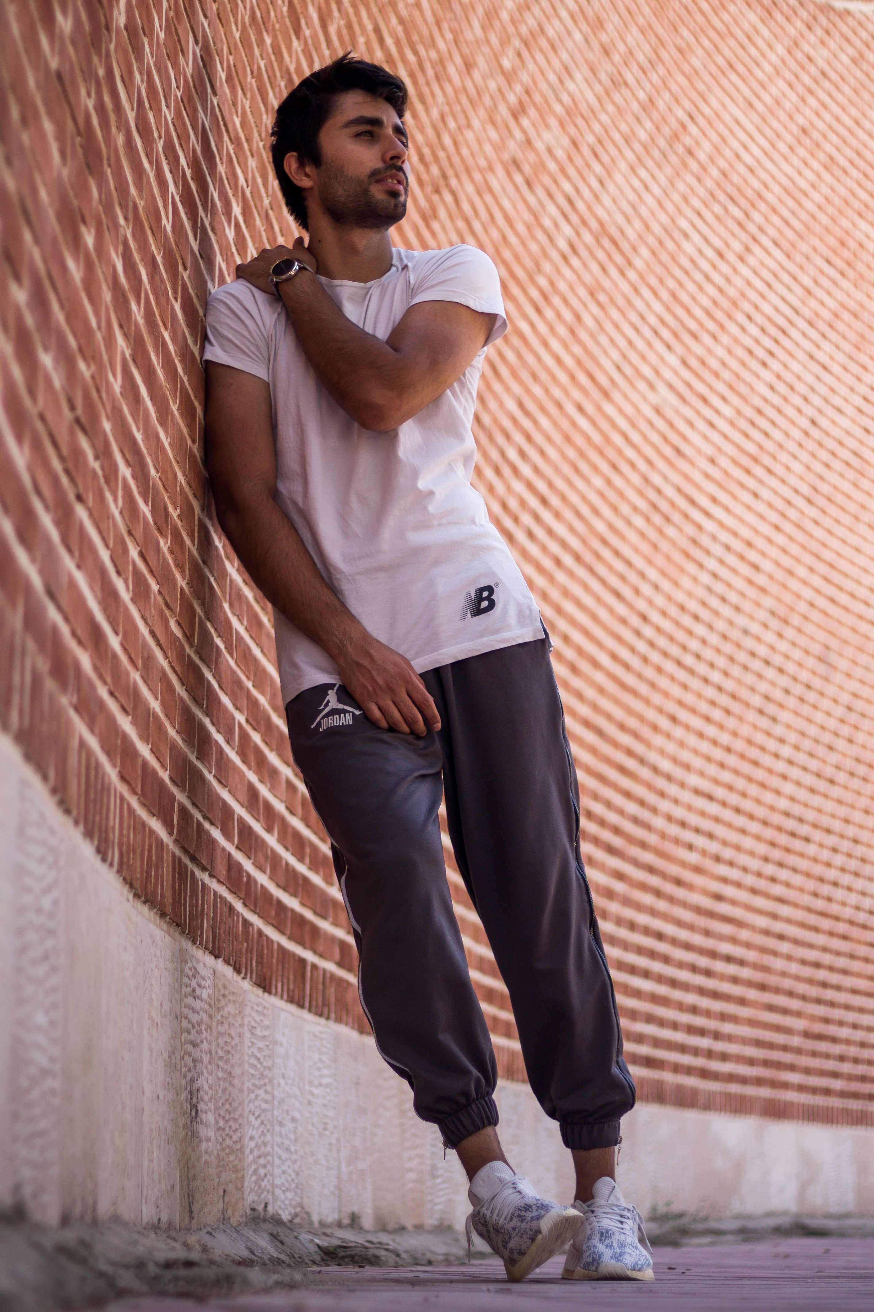 Young Man in a Casual Outfit Standing with His Back against the Wall ...