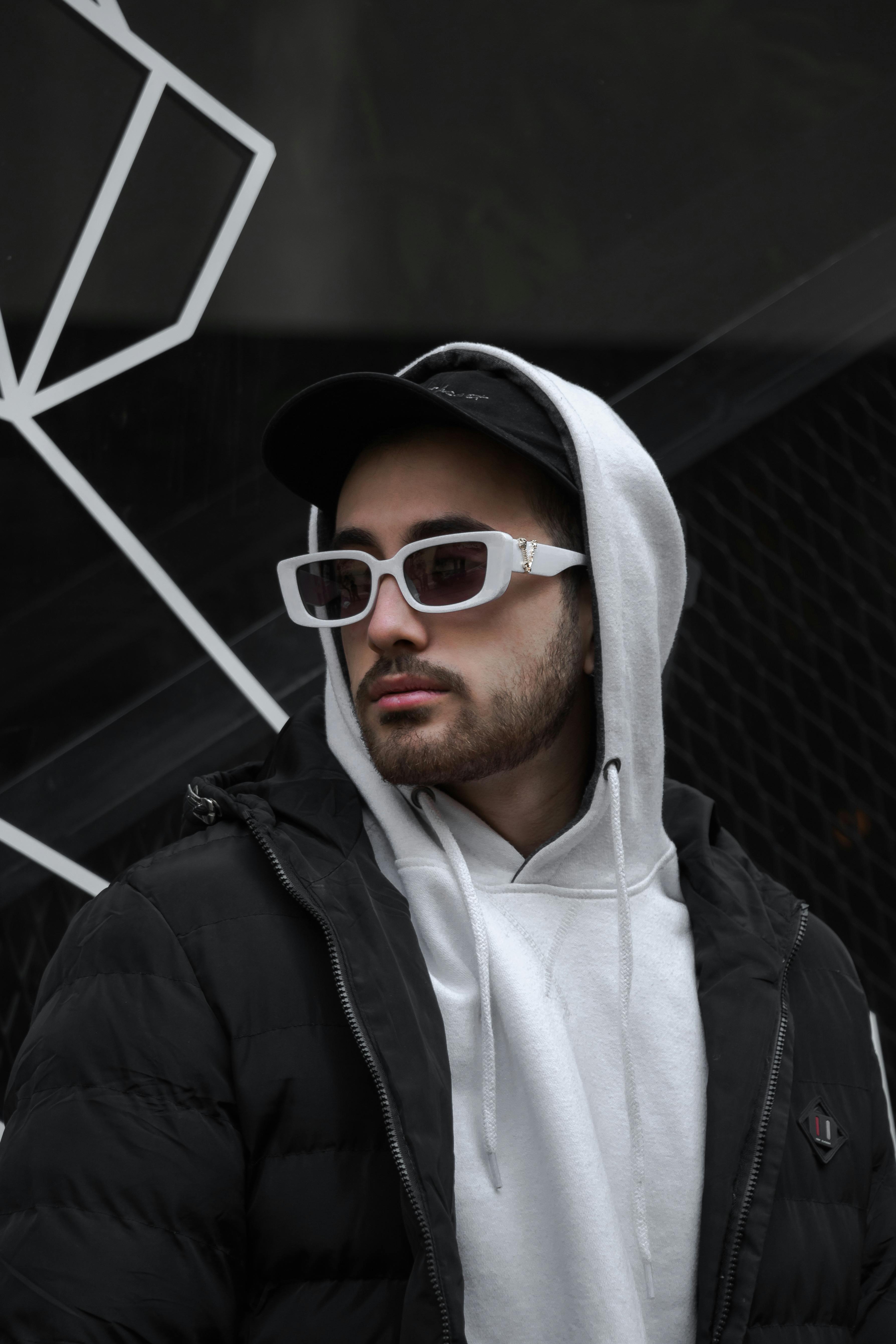 Young Man Wearing a Hoodie, Jacket and Sunglasses · Free Stock Photo