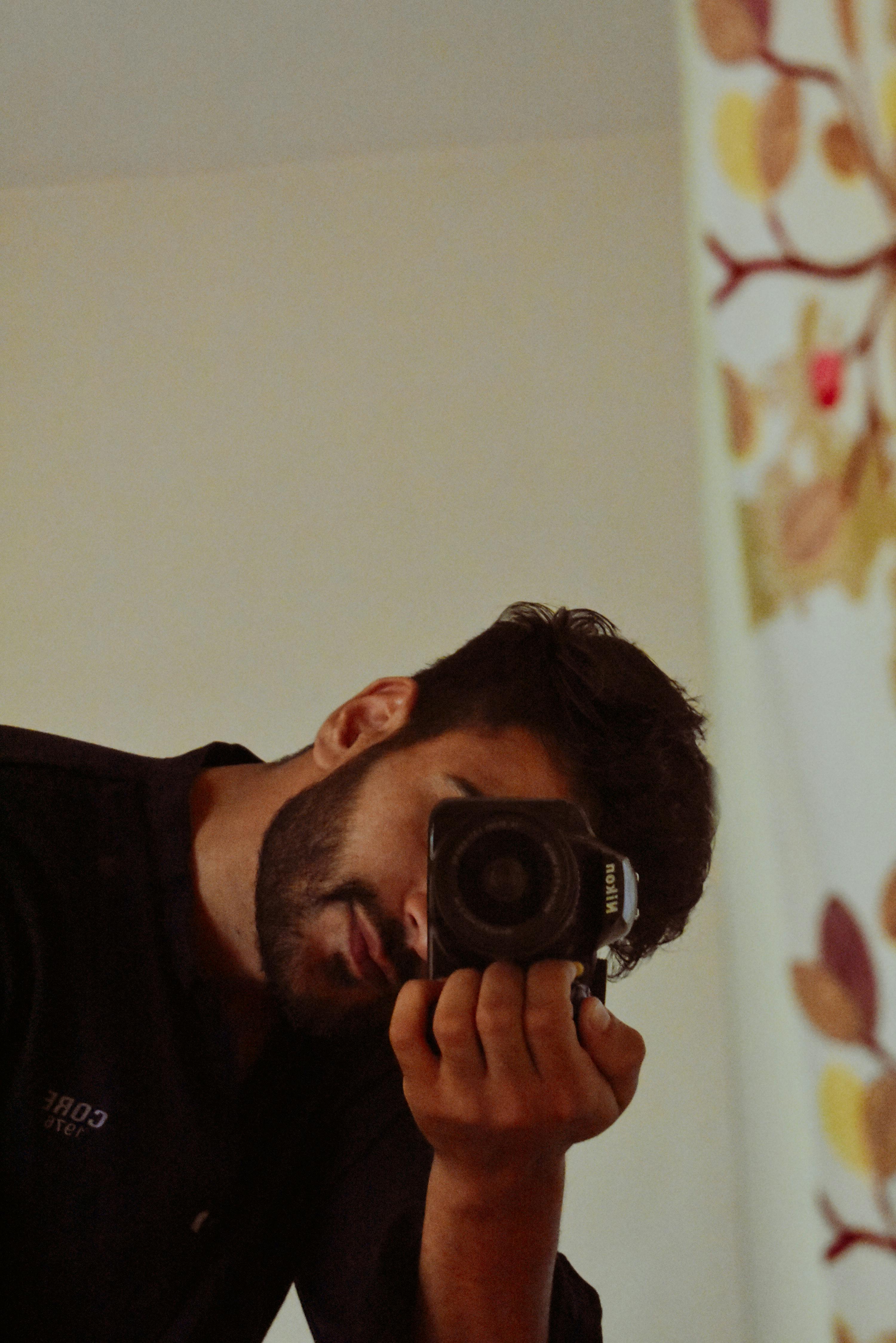 Man Taking a Picture with a Camera · Free Stock Photo