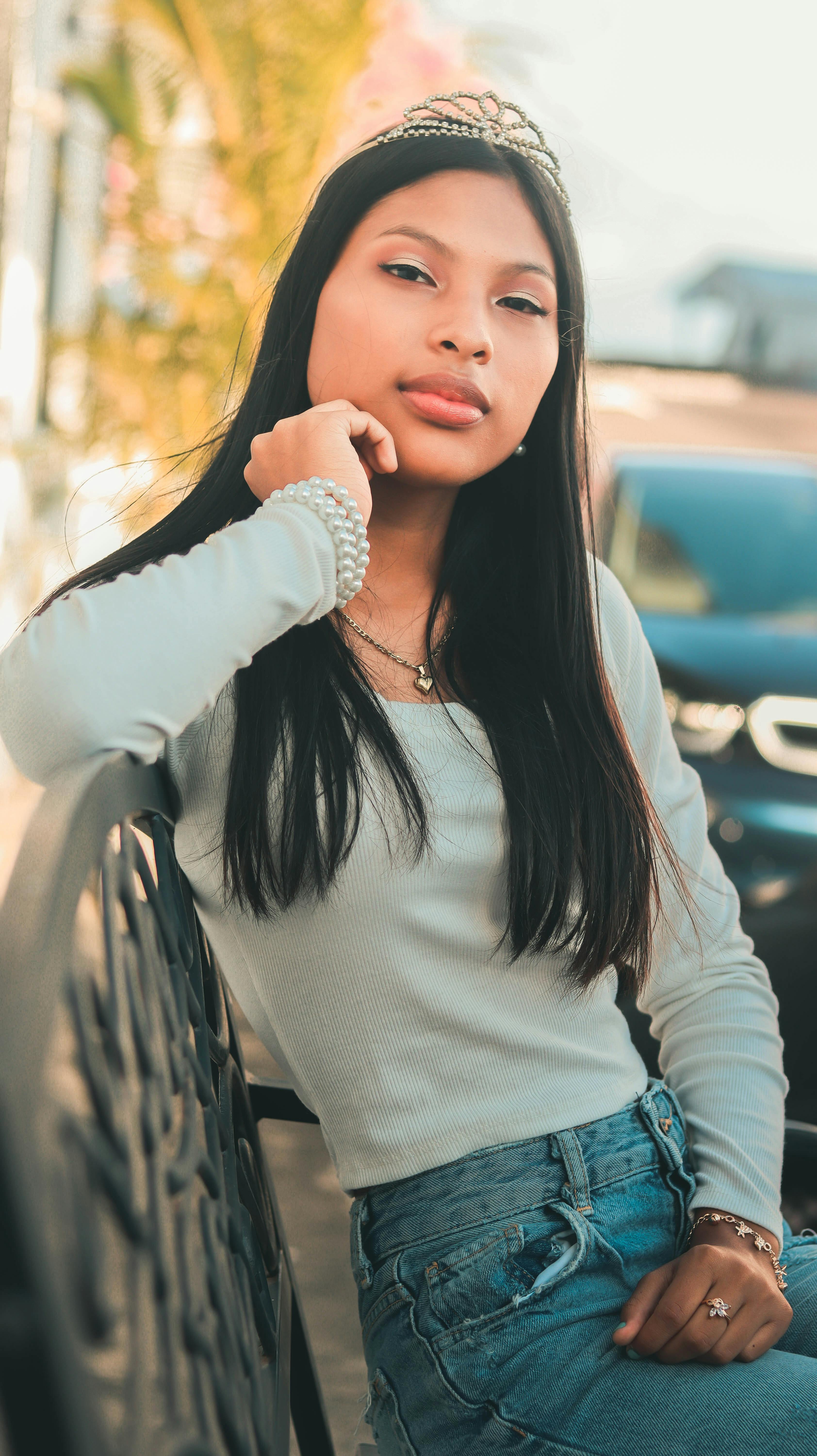 Brunette in Tiara Sitting on Bench · Free Stock Photo