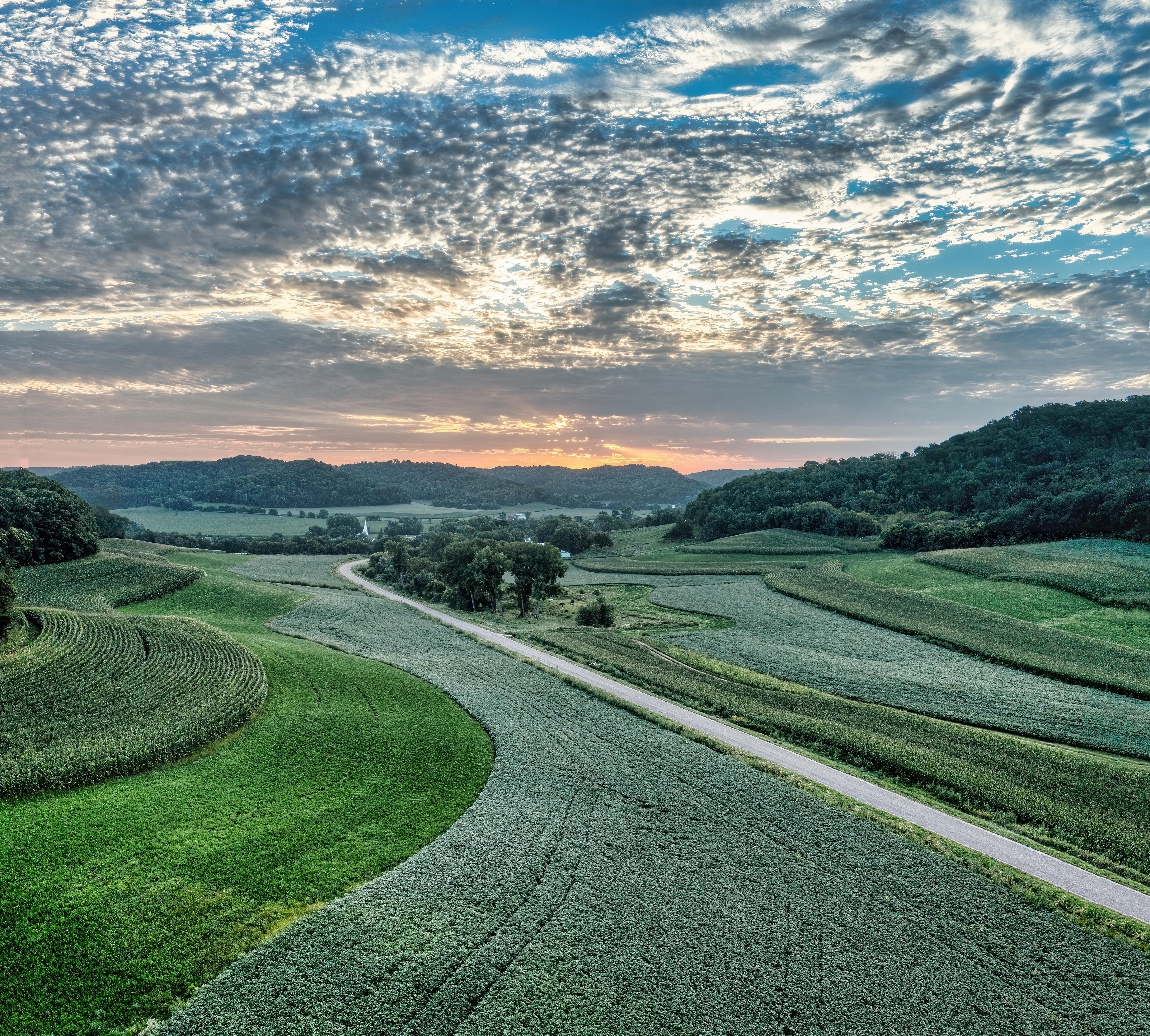 Scenic View of Landscape Against Cloudy Sky · Free Stock Photo