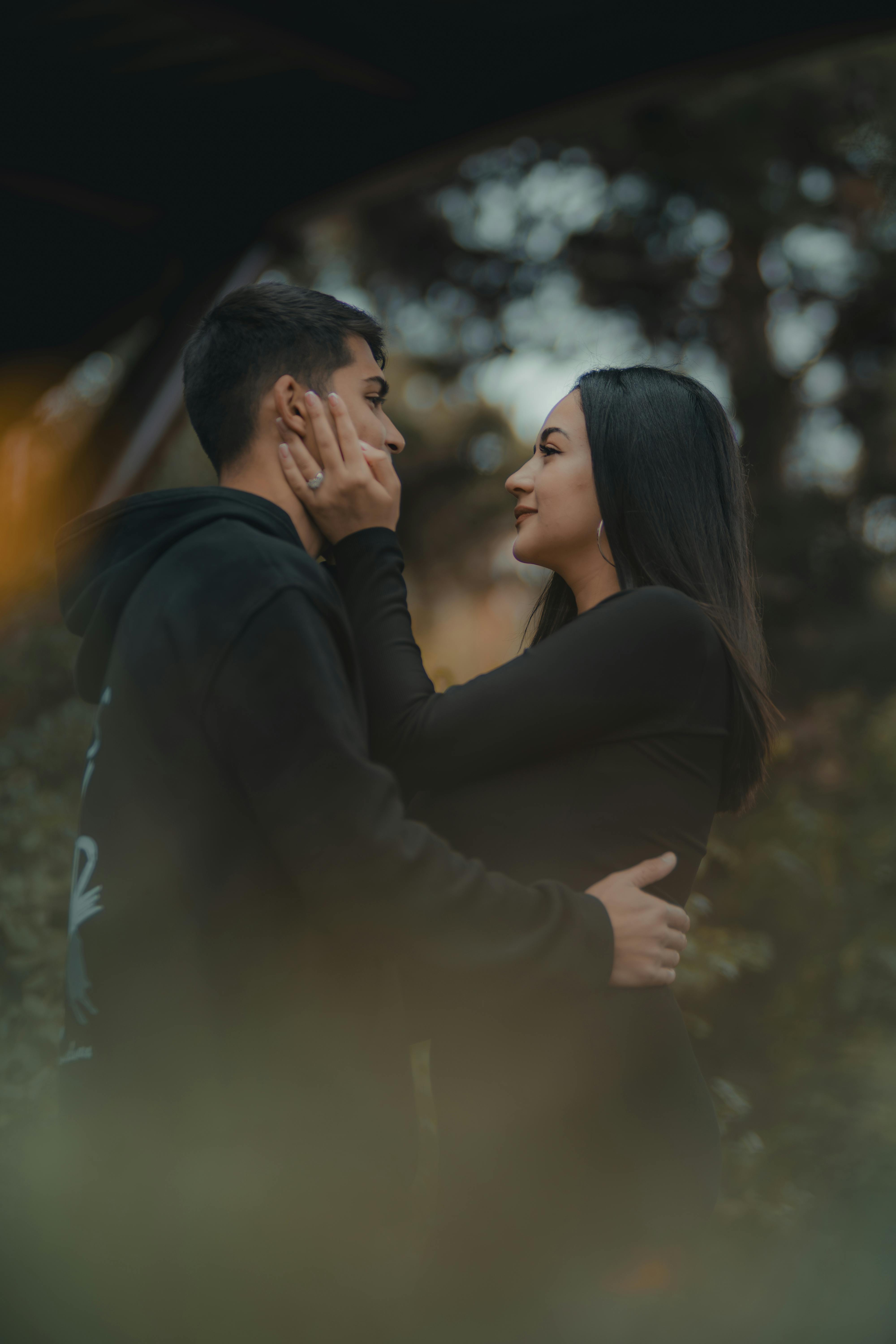 Woman Holding Hands on Man Neck at Sandy Beach · Free Stock Photo