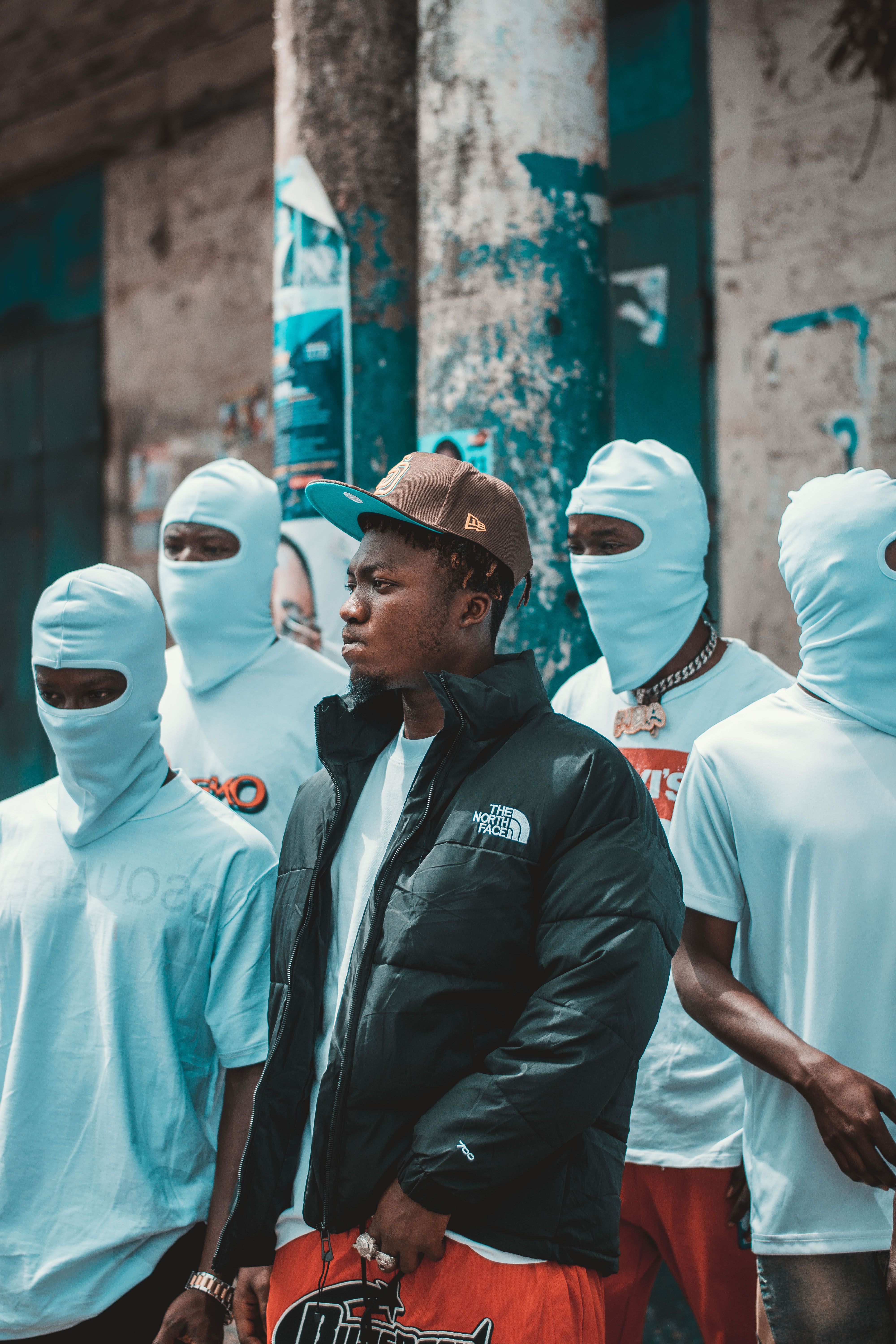Man in Black Puffer Jacket Standing in a Group of Men in Balaclavas ...