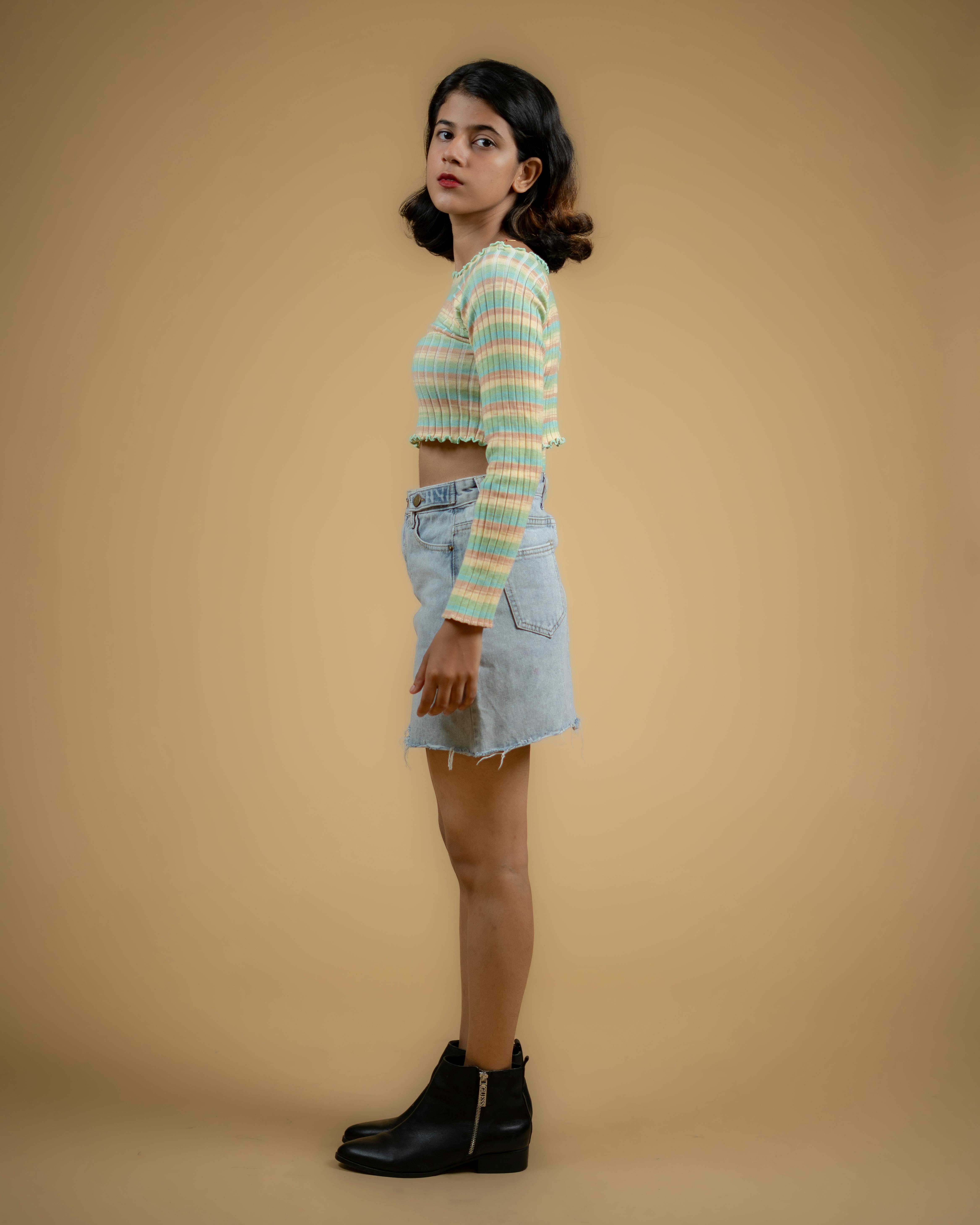 Woman Wearing Sweater and Denim Skirt in a Studio · Free Stock Photo