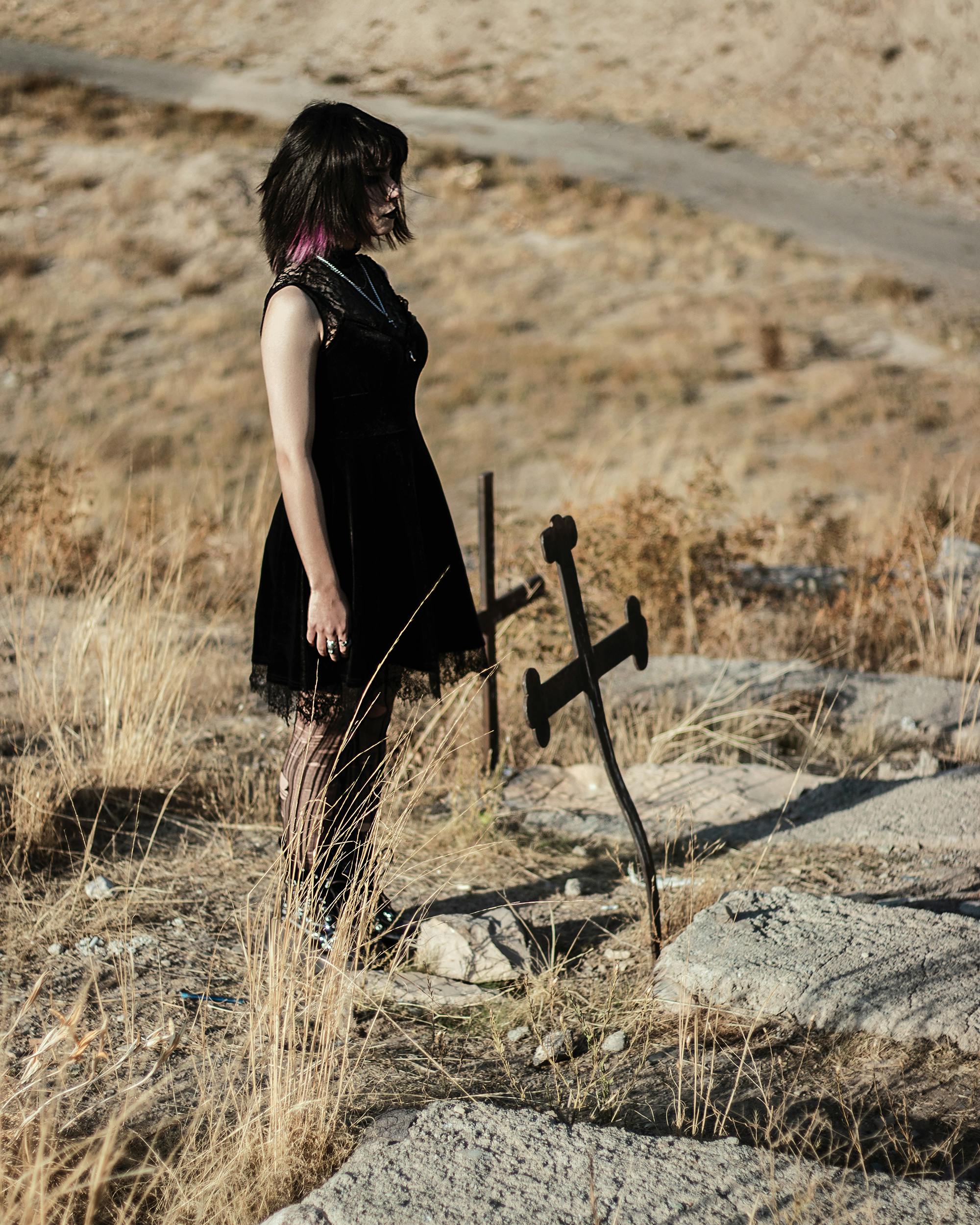 Goth Girl Sitting on Ground in Cemetery · Free Stock Photo