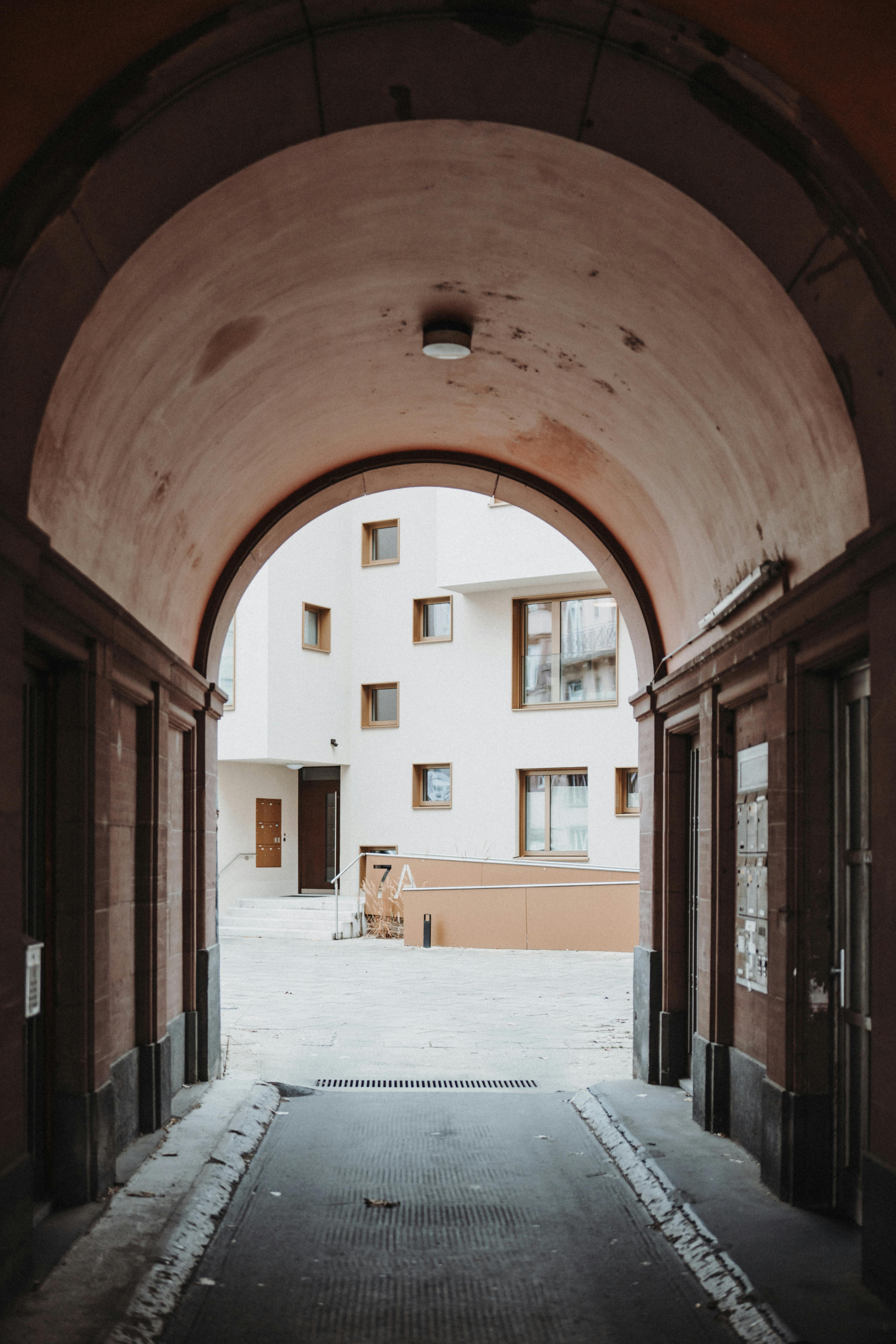 Apartment Building in the Light of the Arched Passageway Through the ...