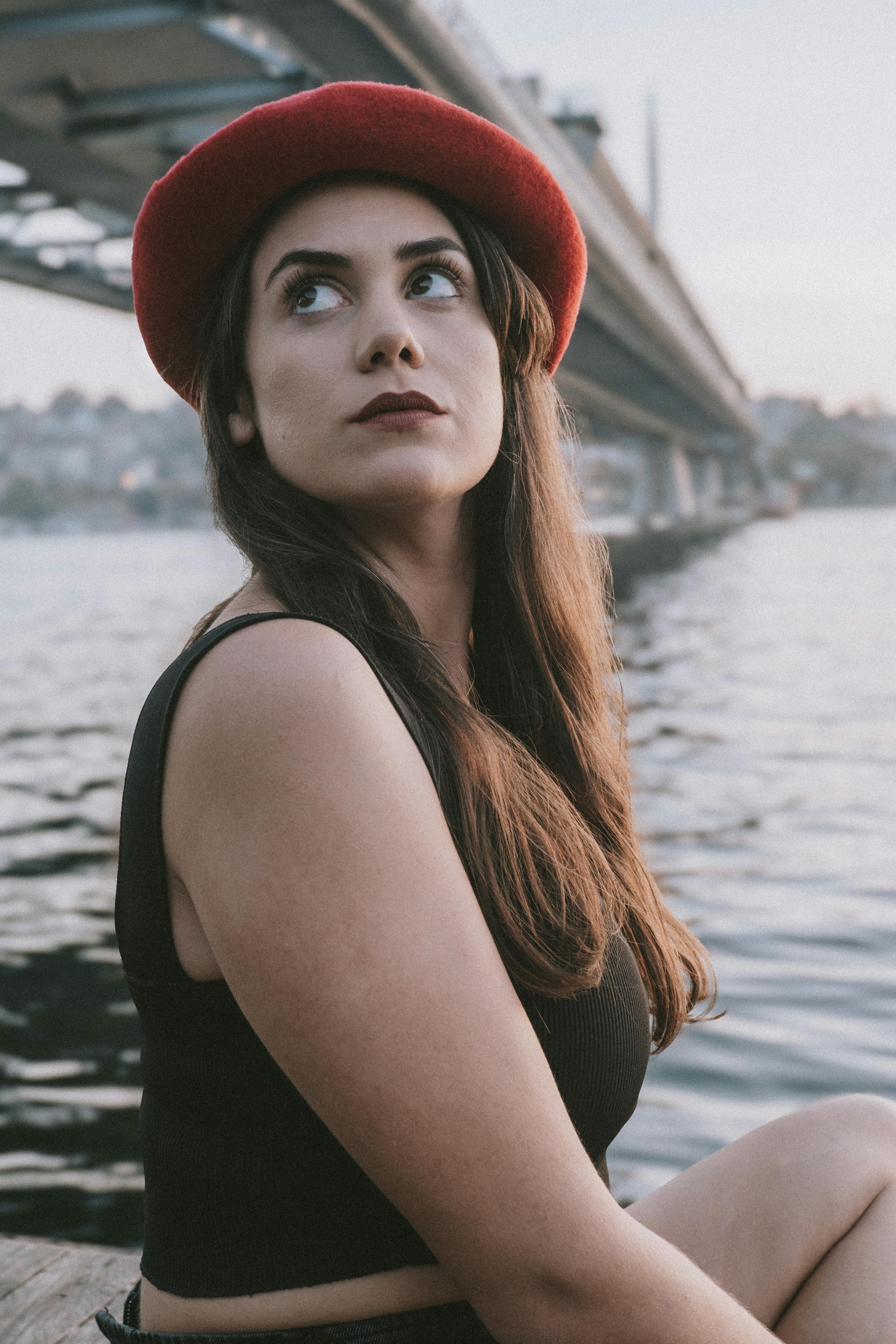 Woman in Beret Sitting on Sea Shore under Halic Bridge in Istanbul ...