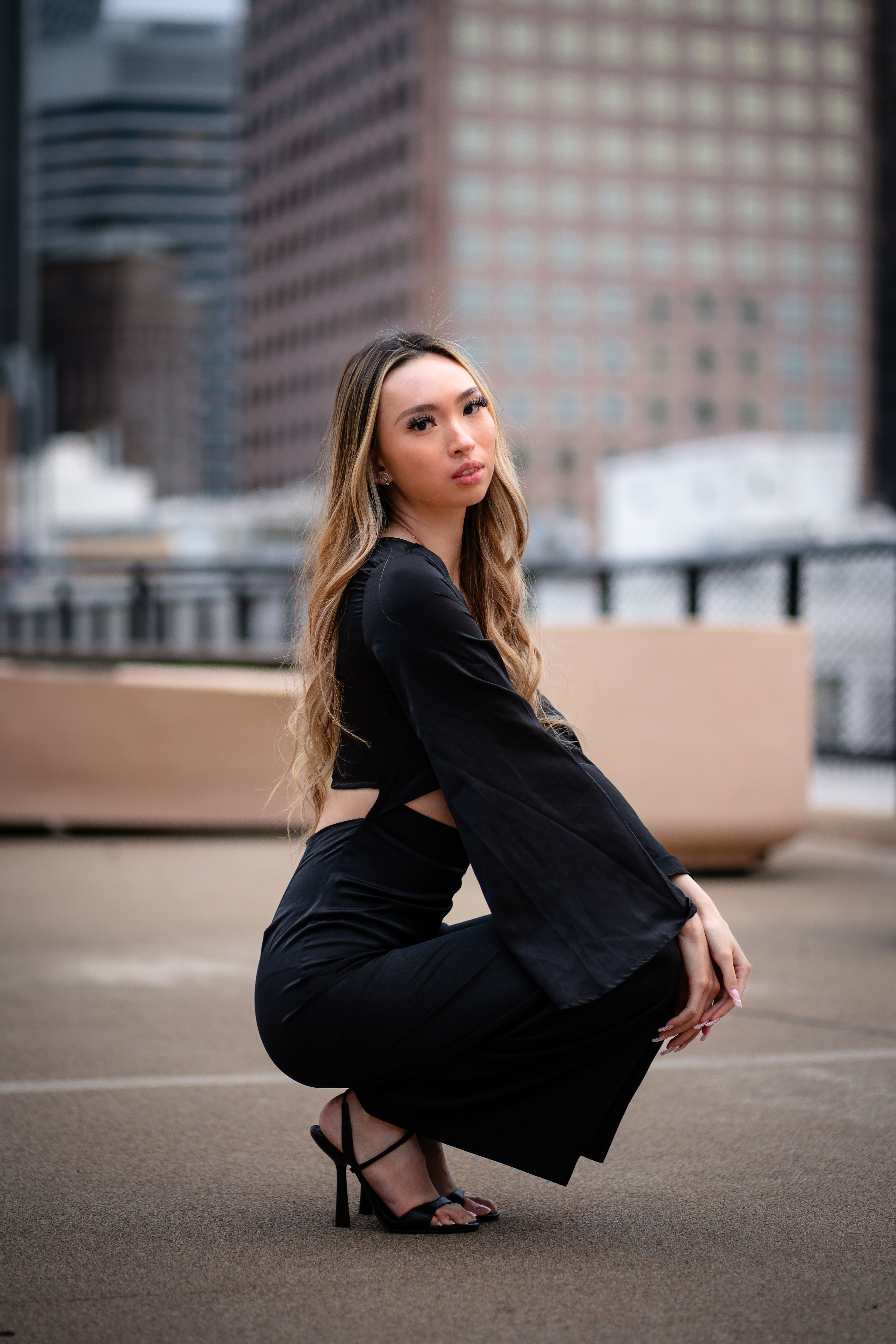 Beautiful Woman in Black Dress and High Heels Crouching · Free Stock Photo