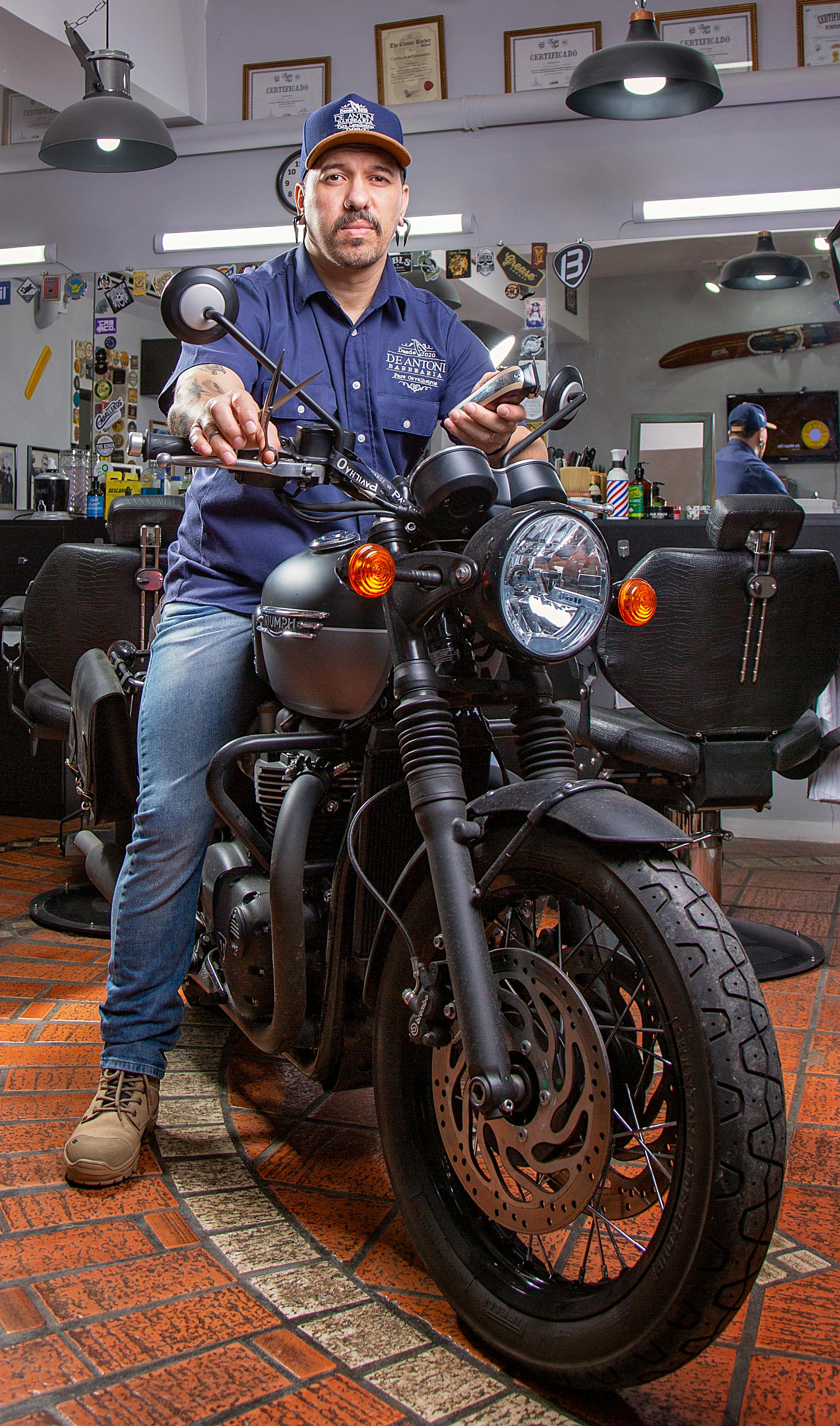 Man with Mustache Posing on Motorcycle in Hair Salon · Free Stock Photo