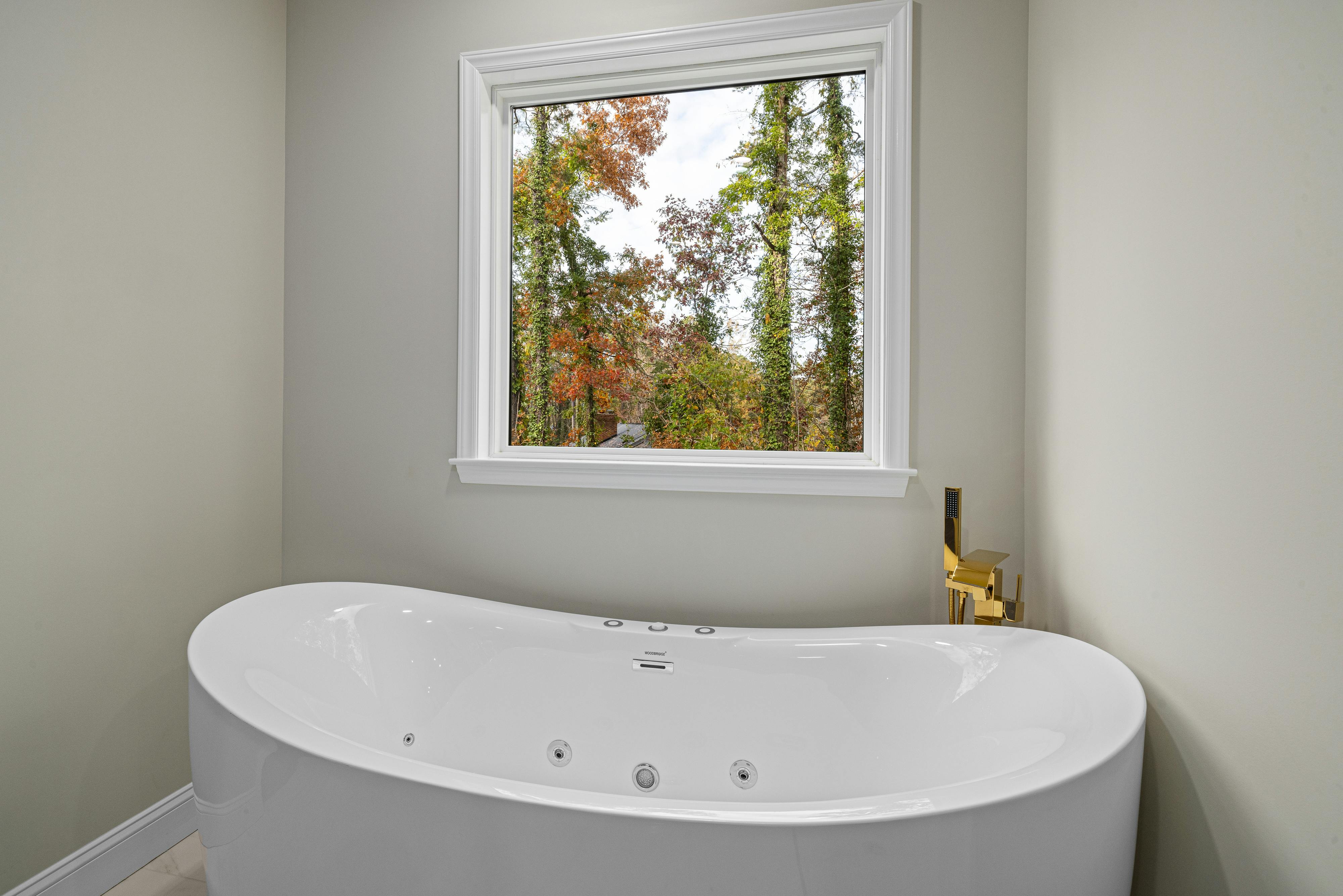Bathtub Standing by the Window in a Modern Bathroom · Free Stock Photo