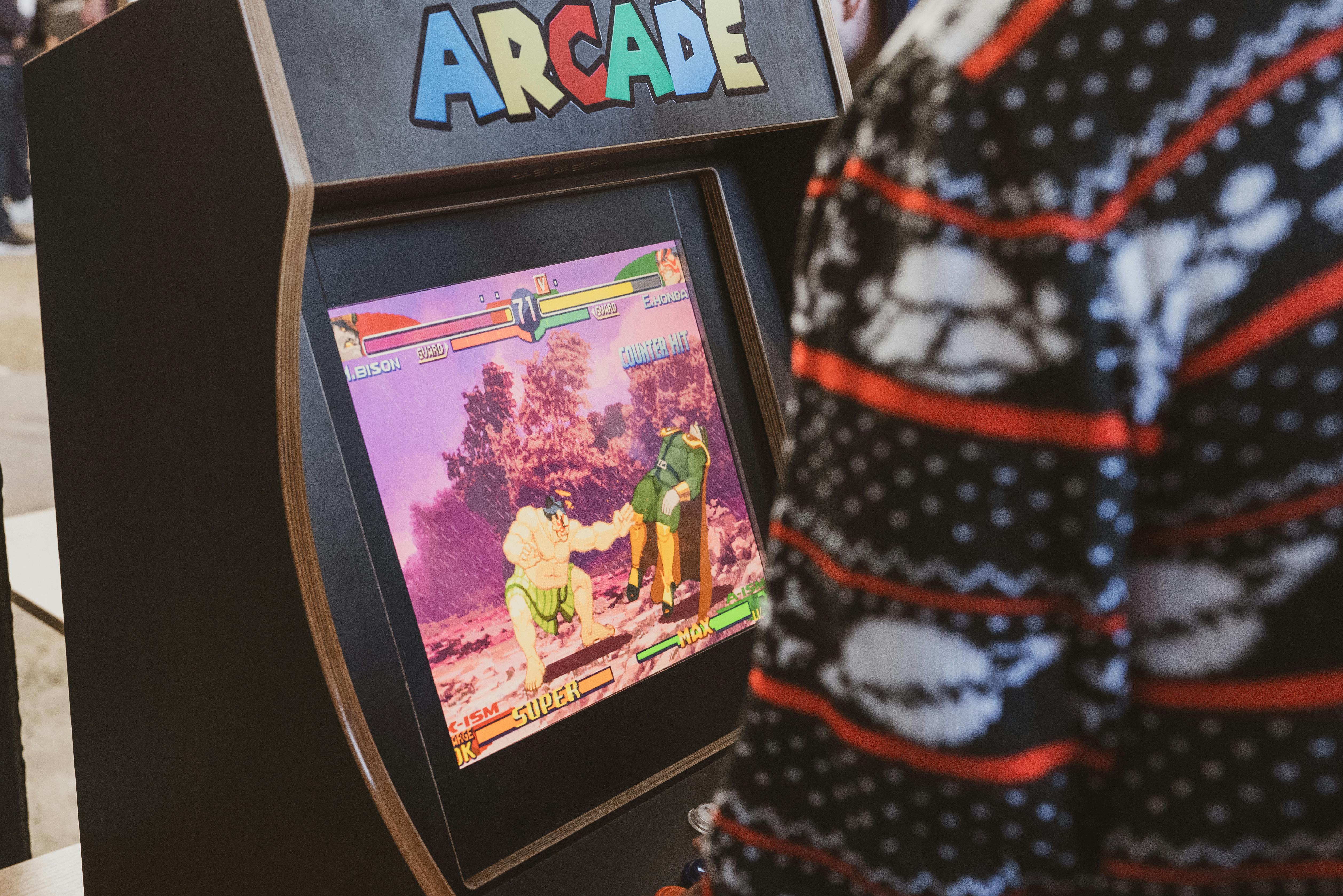 Person Playing on Arcade Machine · Free Stock Photo
