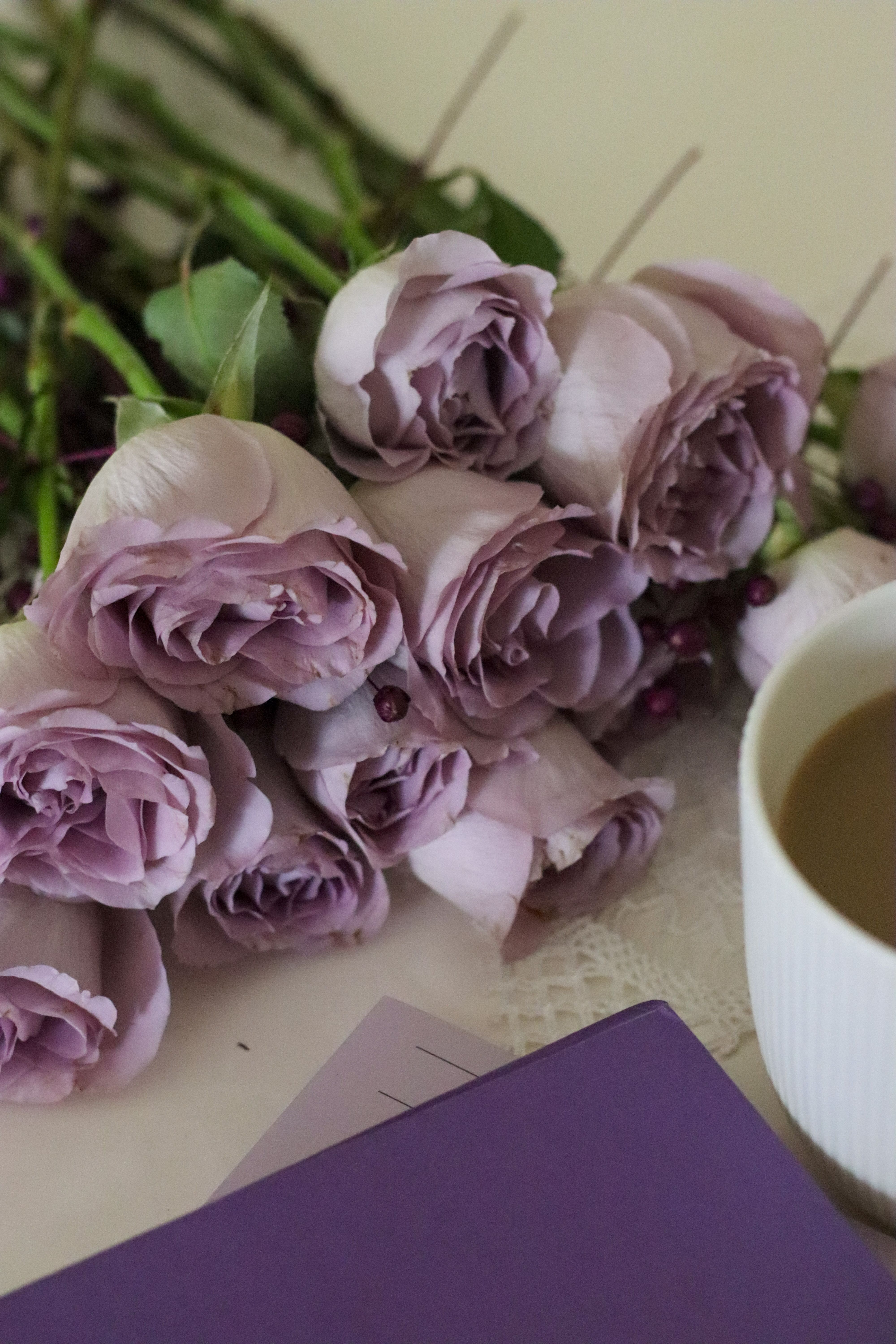 A Cup of Coffee with a Snack Standing on a Tray next to a Bouquet of ...