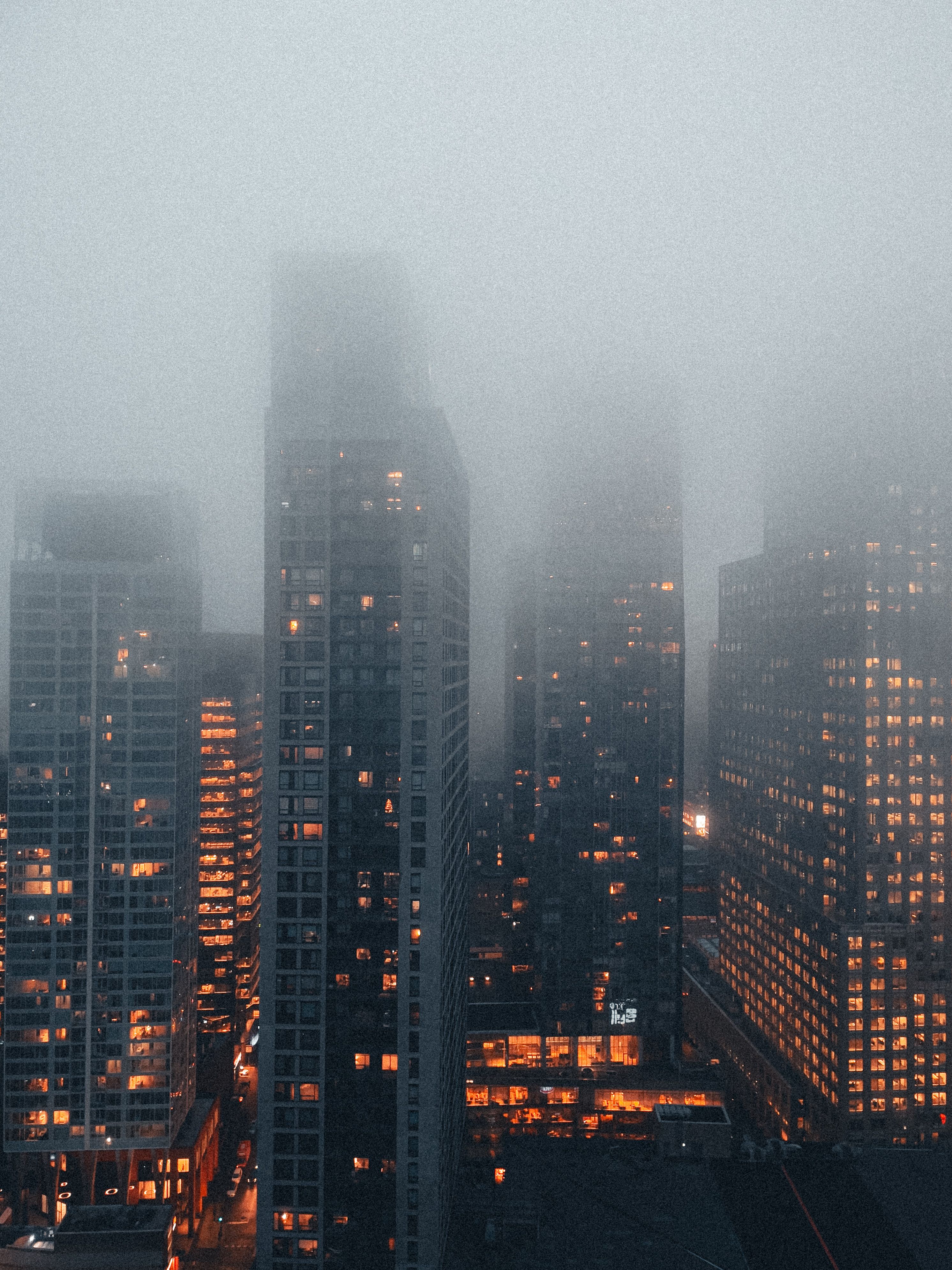 Fog Over Skyscrapers with Illuminated Windows · Free Stock Photo